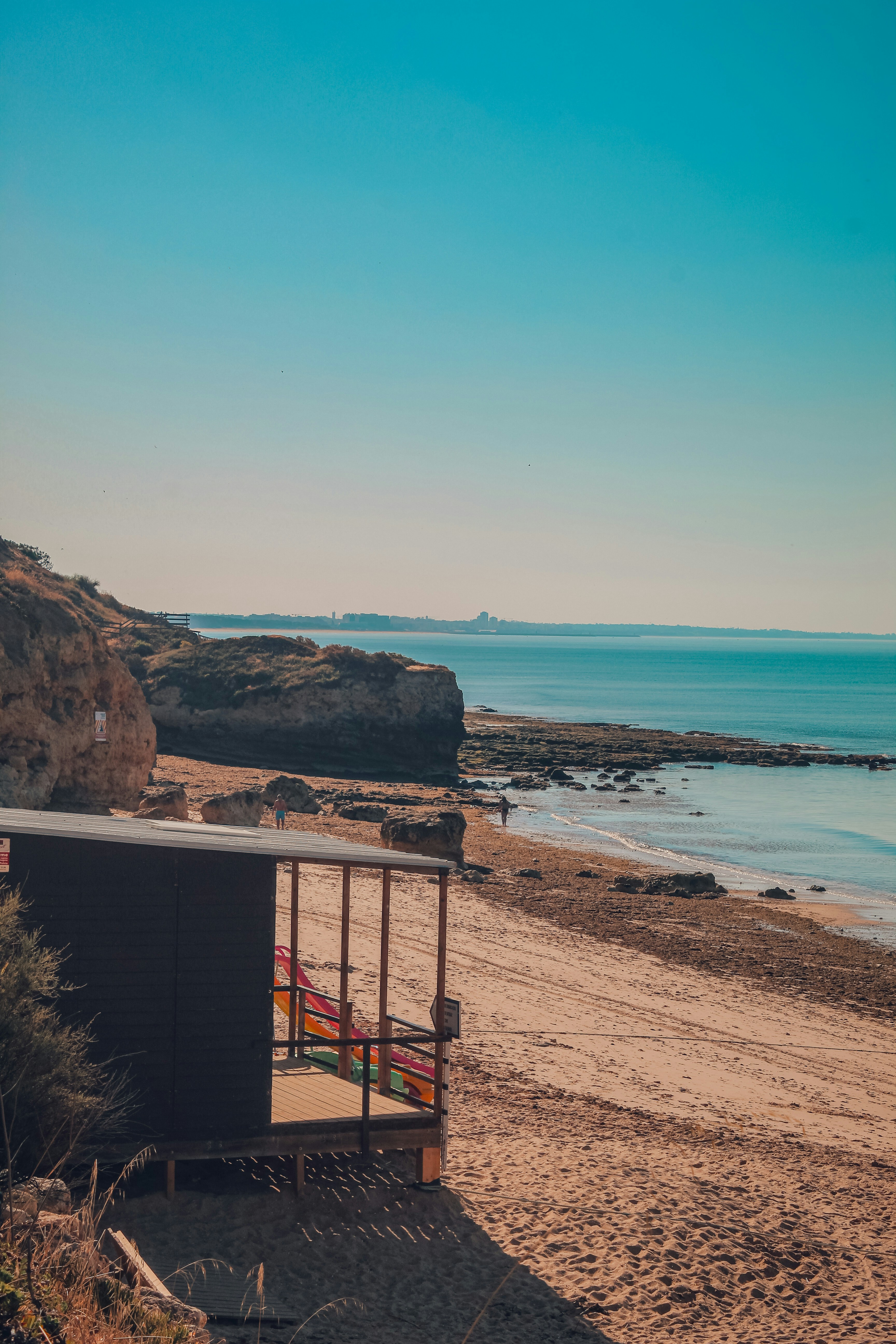 Sunlit Beach Retreat Beneath a Clear Sea-Sky Panorama