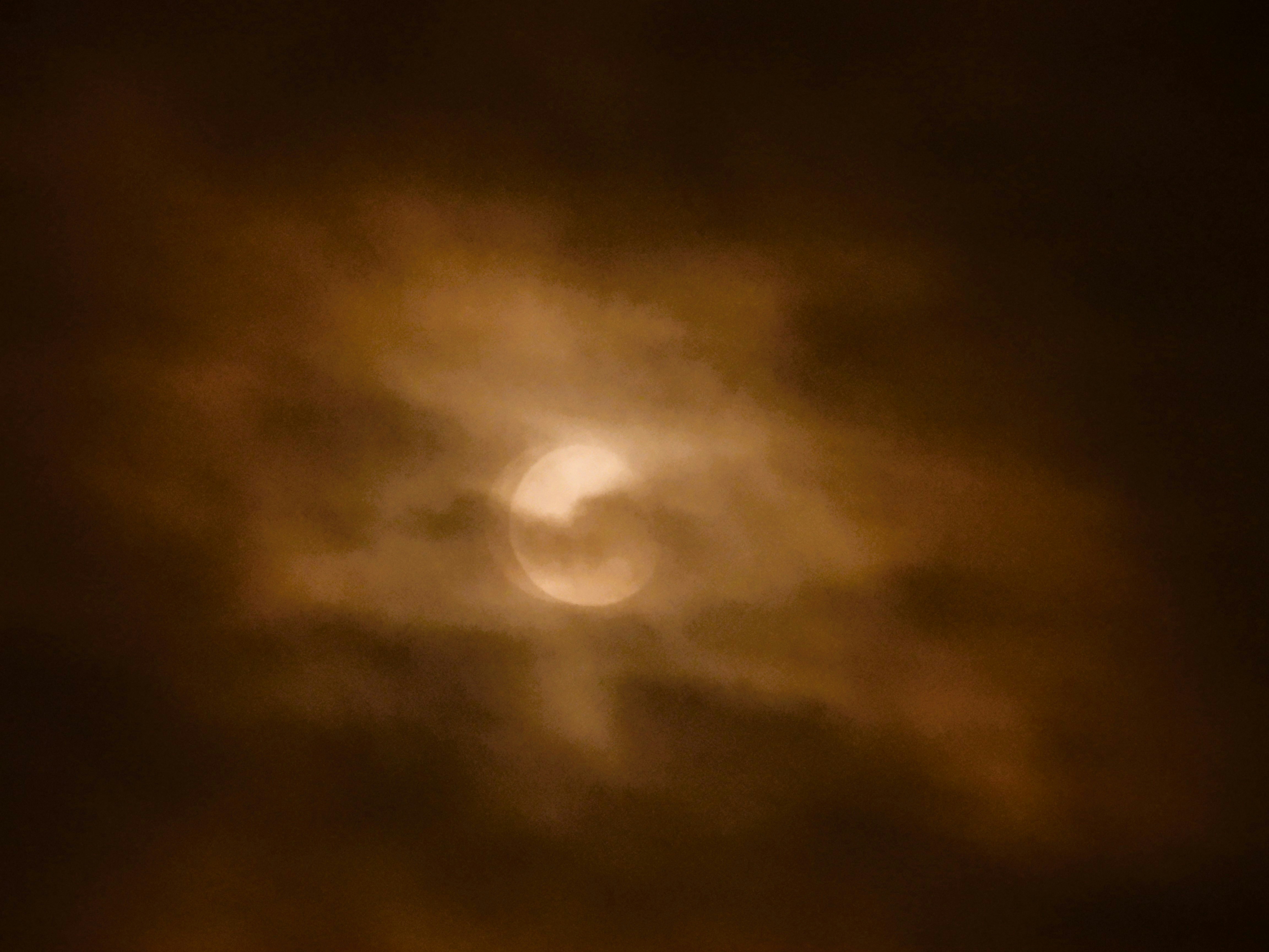 Moon in Golden Mist: A Cloudy Night Portrait