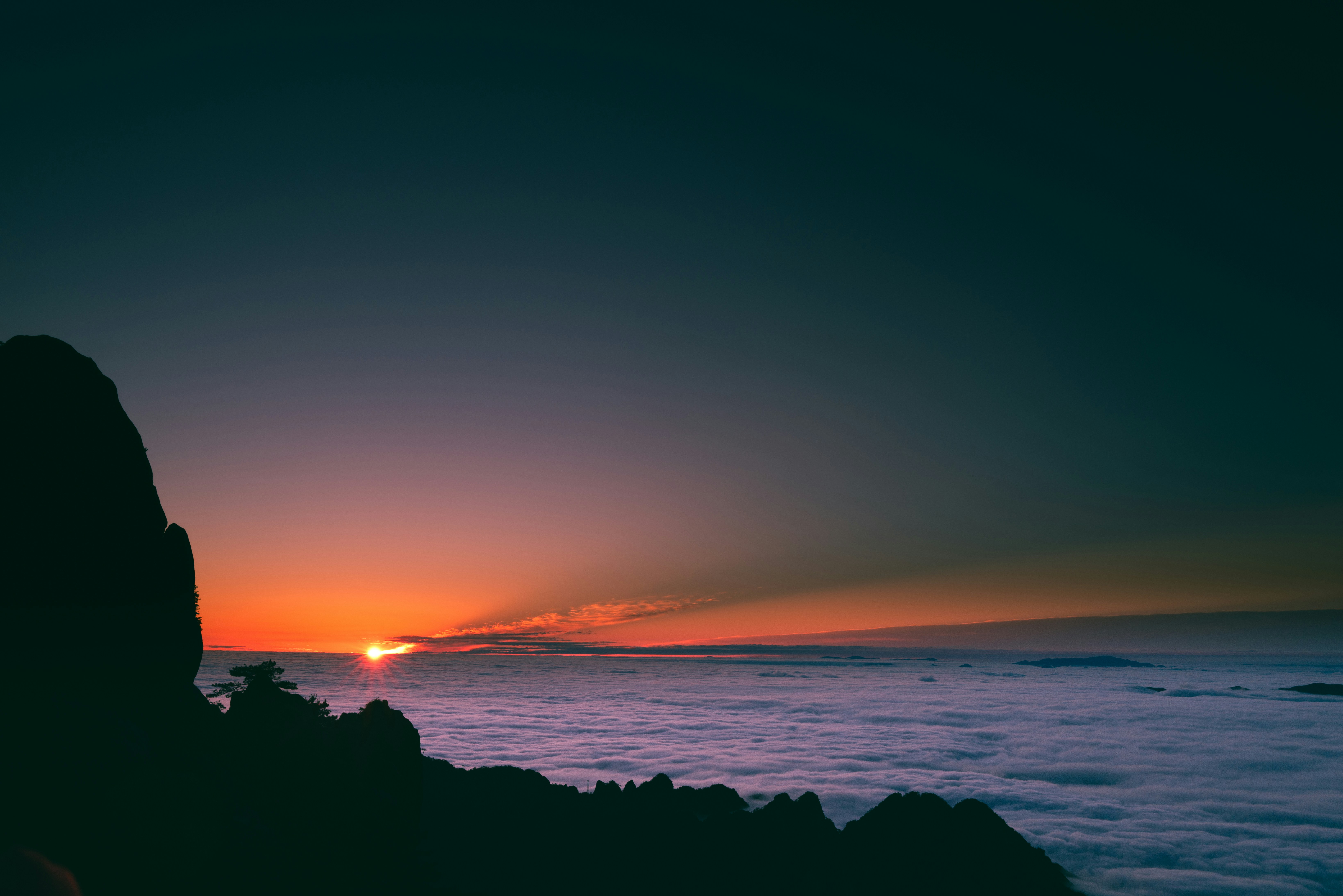 Sunlit Cliff Edge at Distant Horizon