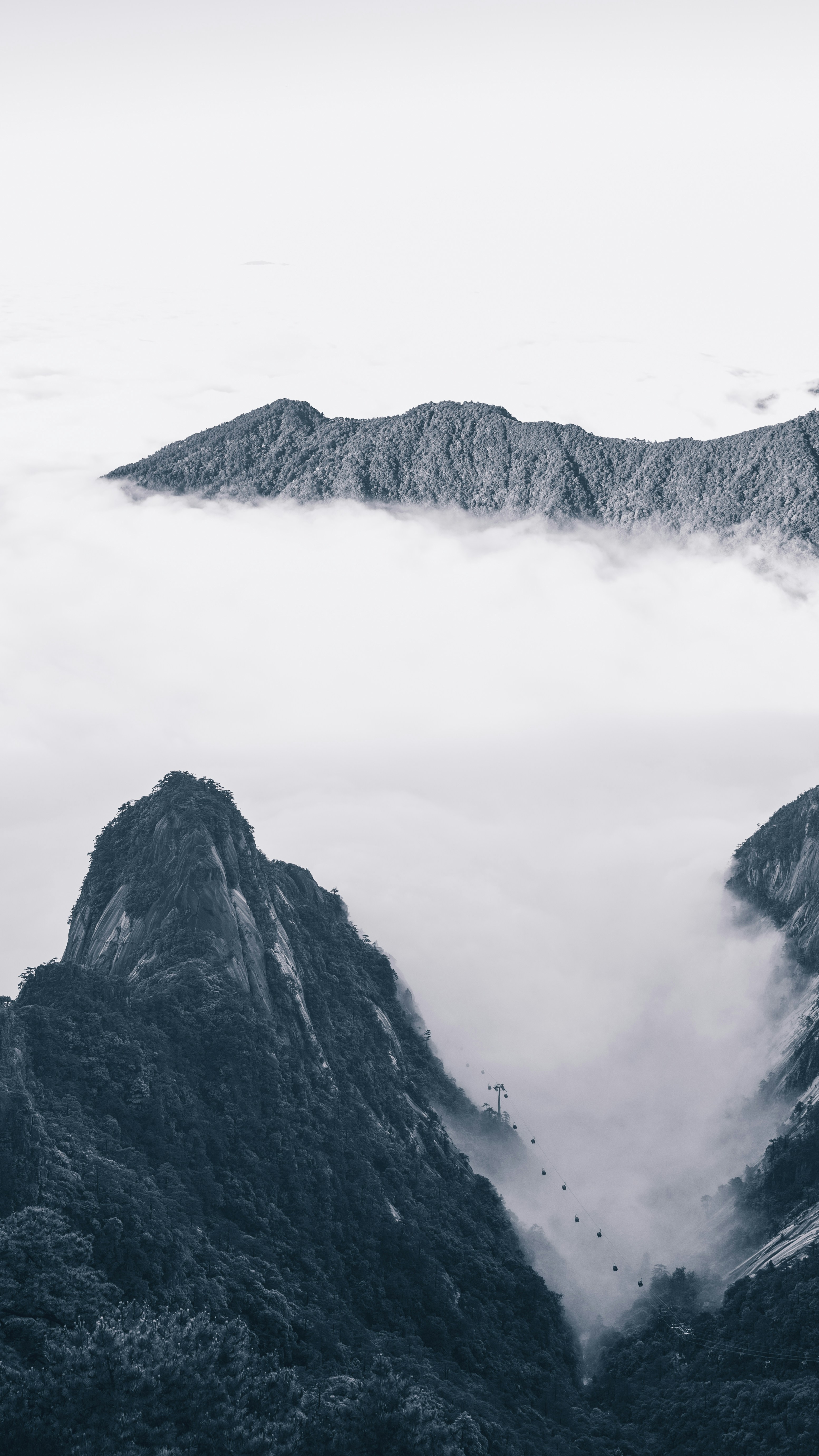 Mist-veiled Peaks: A Ridge Crown Emerges from the Clouds