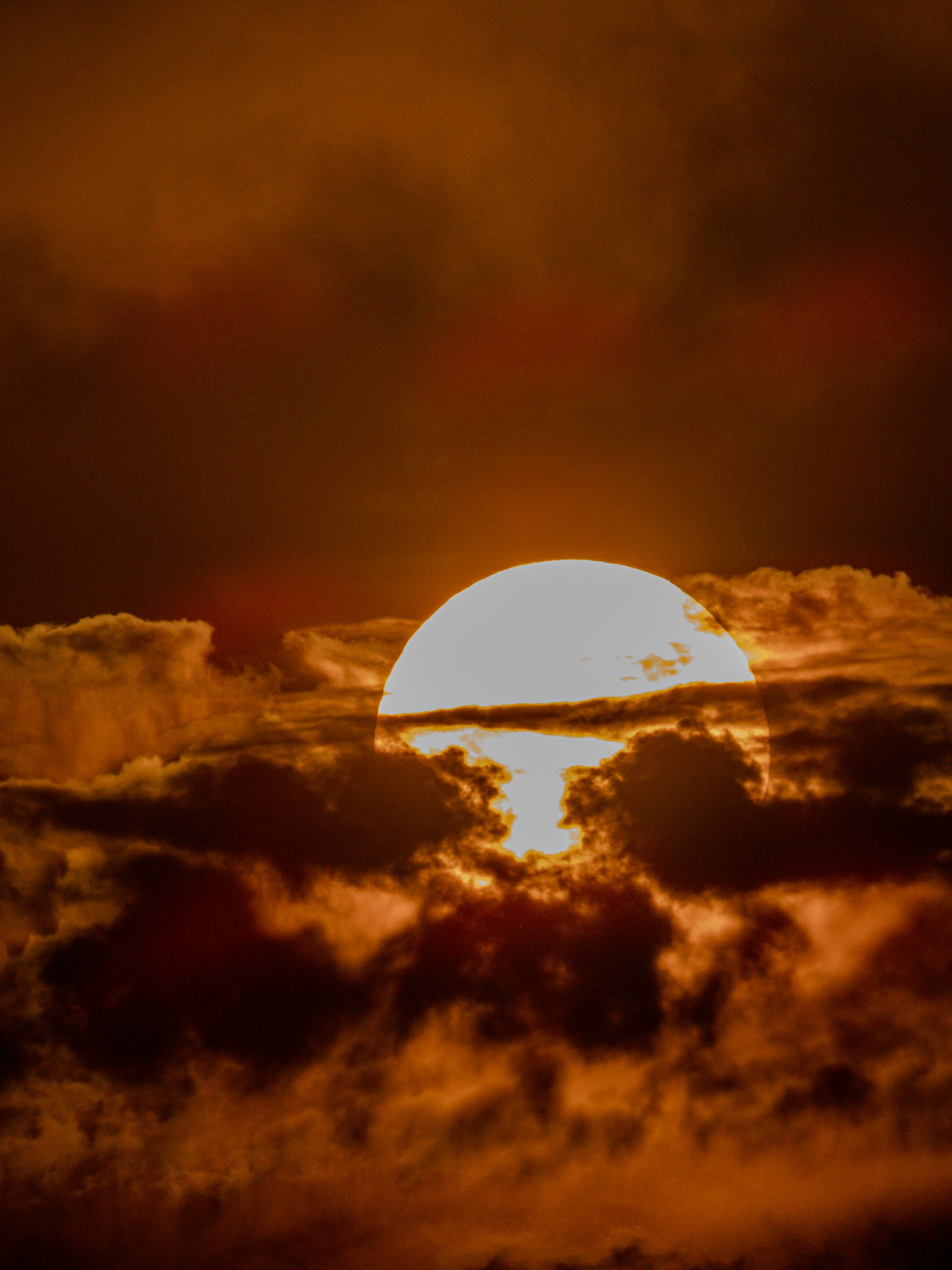 Half-Dawn Sun Emerges Through Golden Clouds