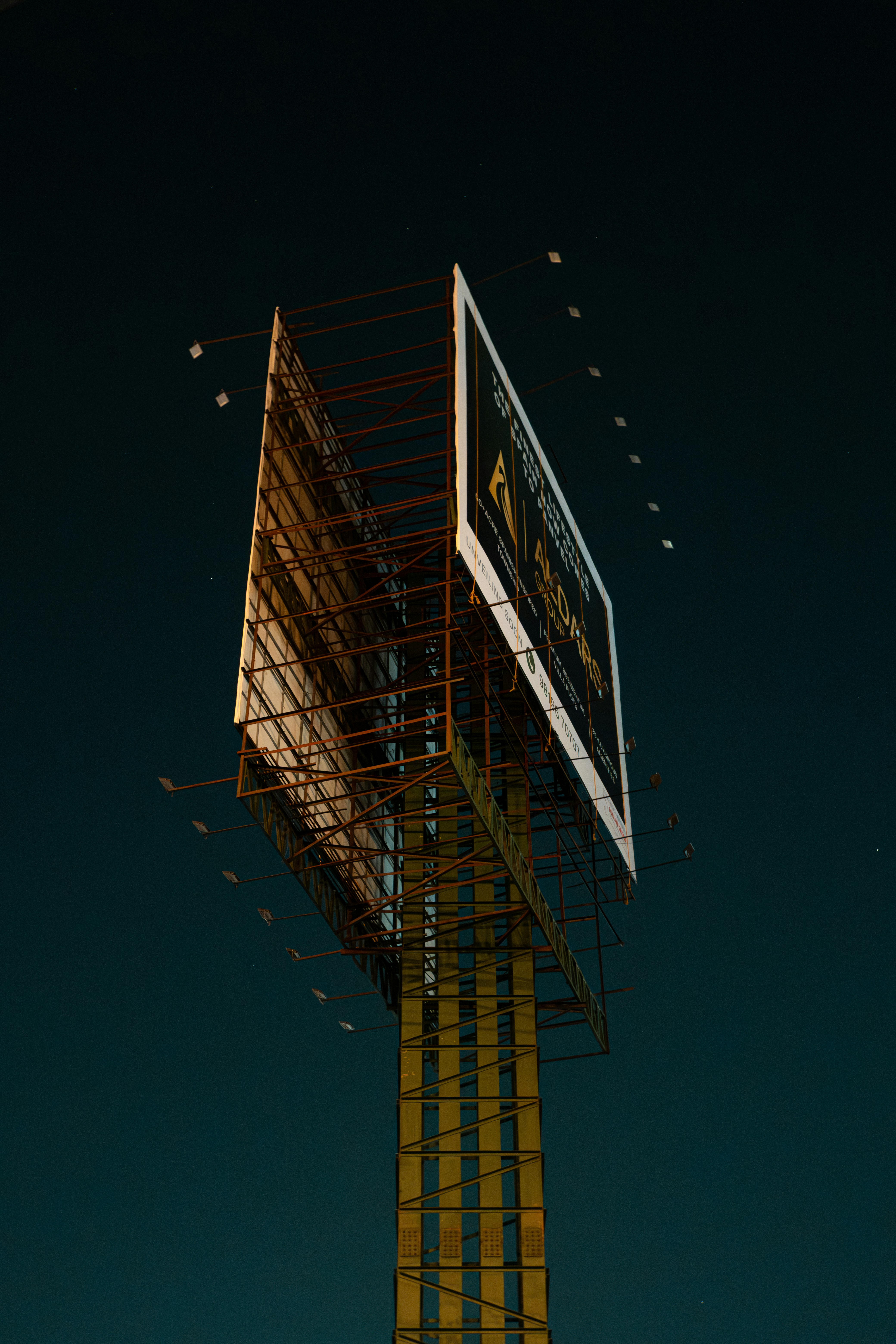Midnight Signpost: A Rooftop Billboard Reaching for the Sky