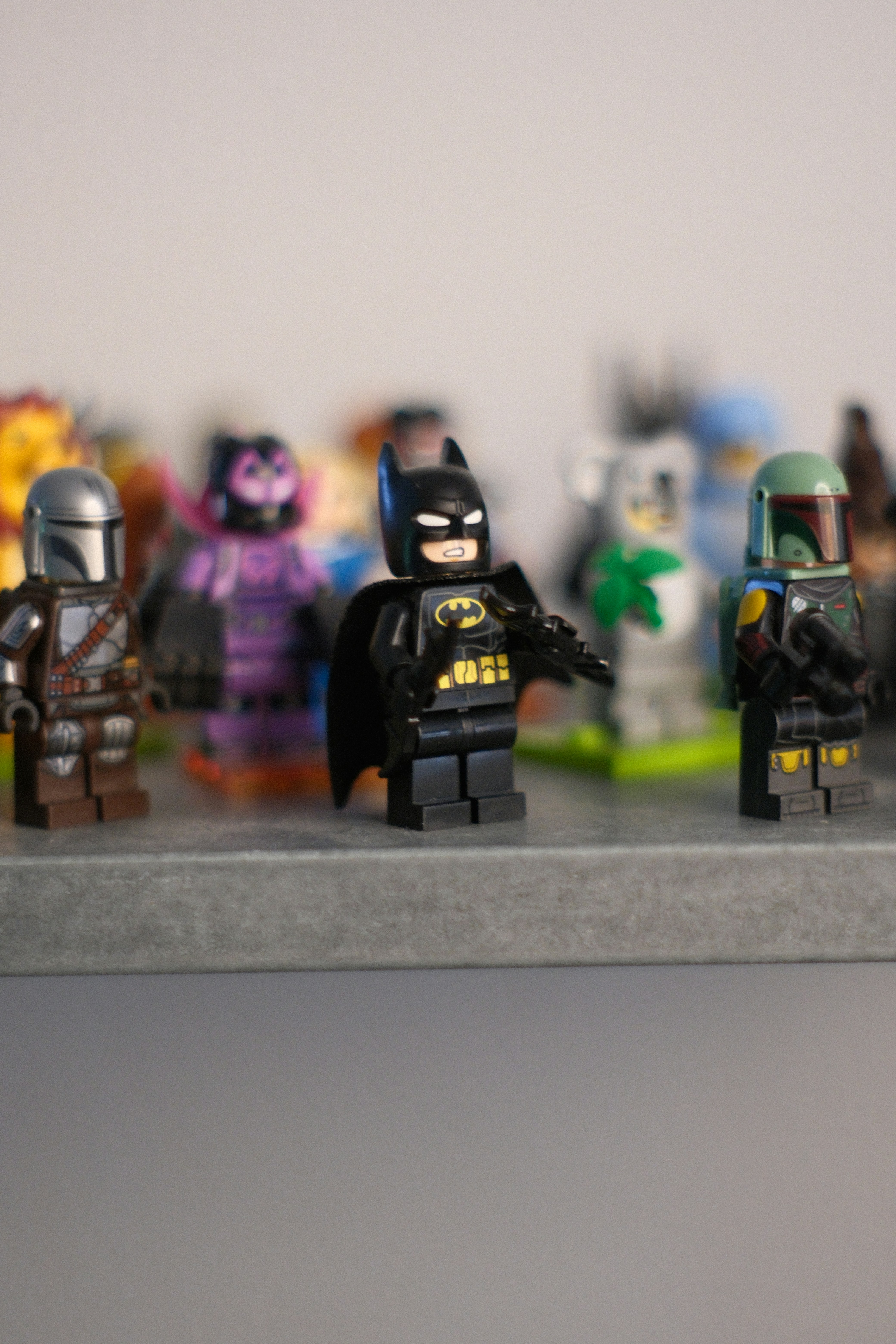 Lego batman, mandalorian, and boba fett minifigures displayed.