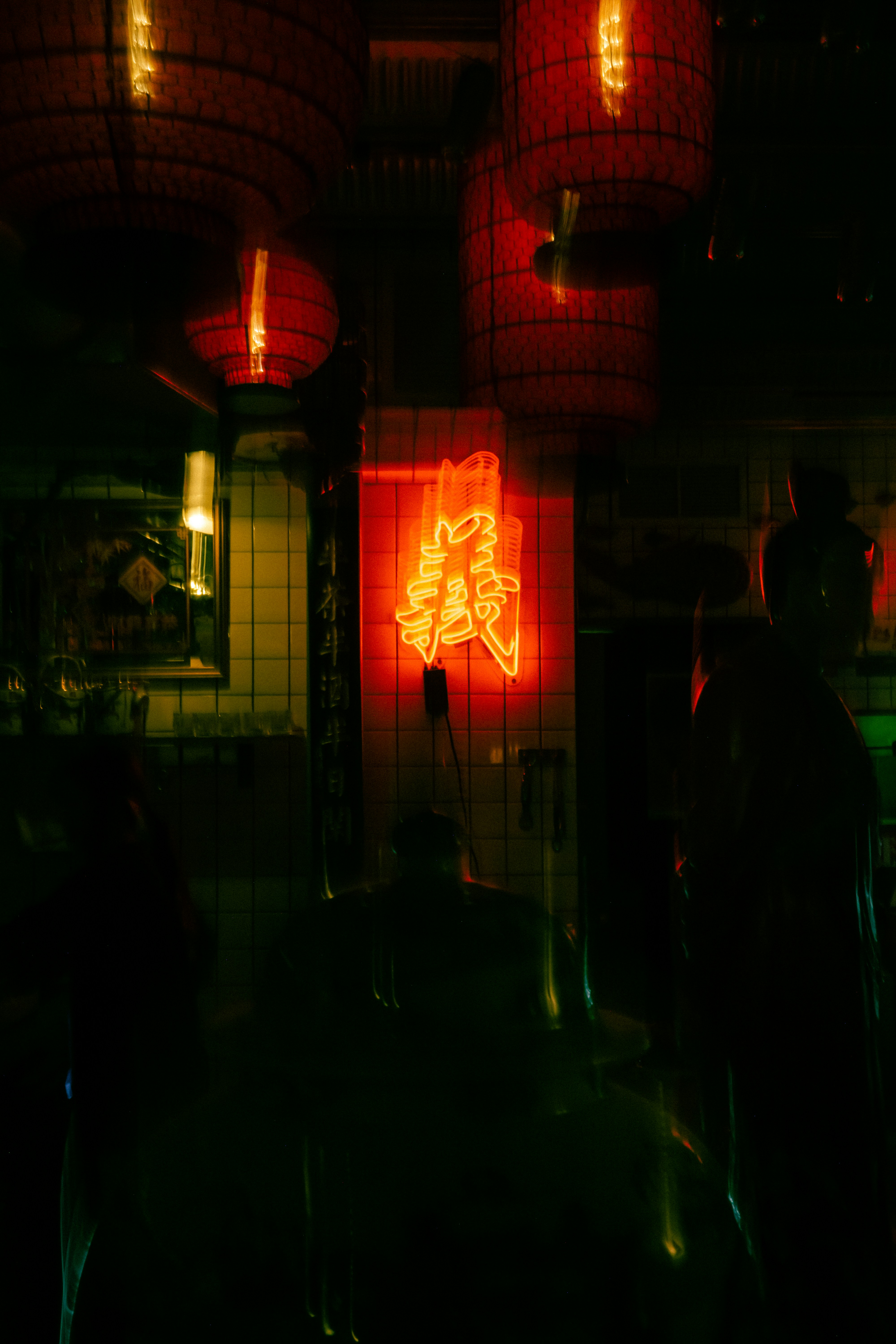 Neon Lanterns and Shadowed Interior