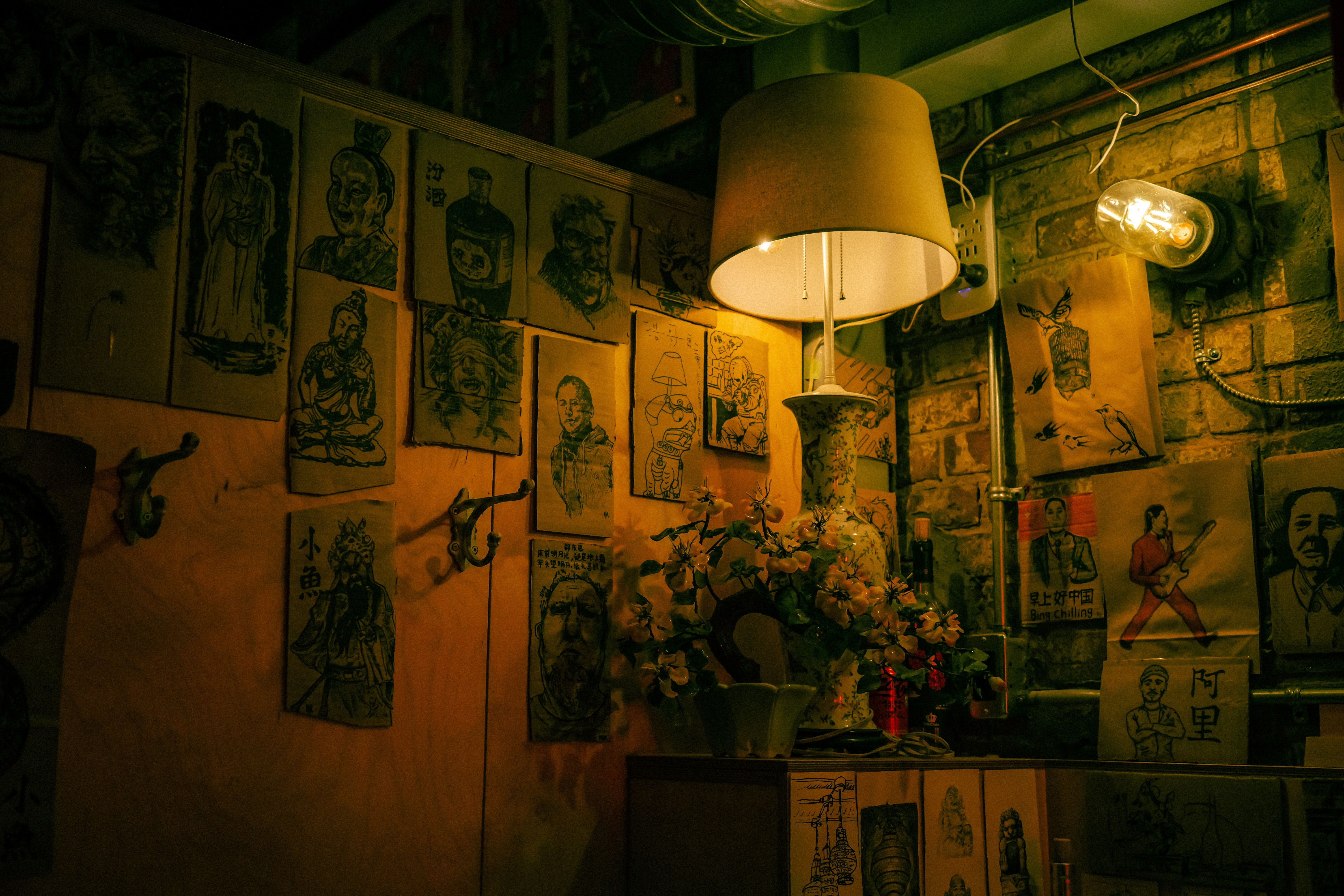 Quiet Shrine: Dim Lamps and Portraits in a Cozy Wall Gallery