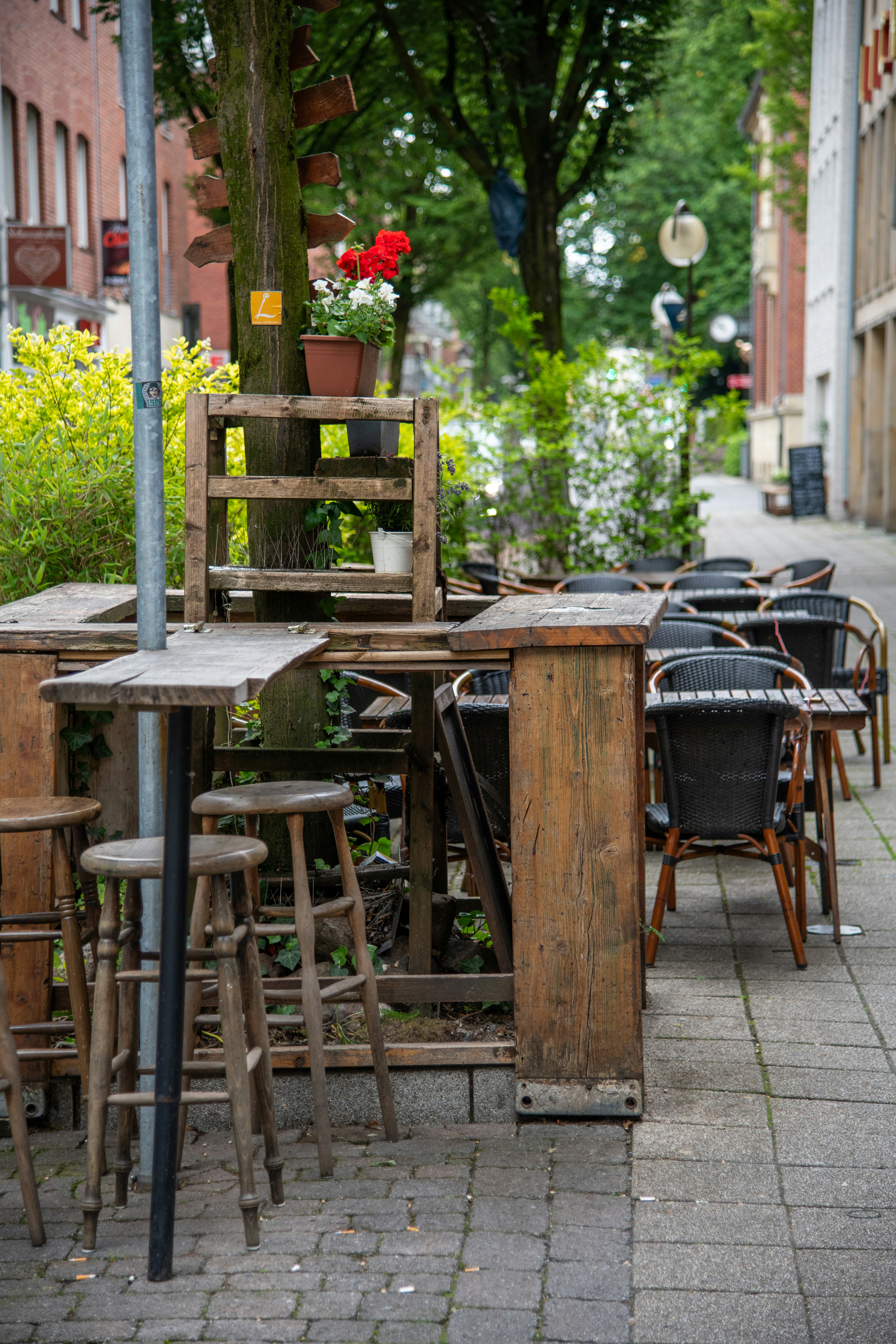 Street-side Bistro in Bloom: Weathered Wood, Fresh Paint, and a Quiet Sidewalk