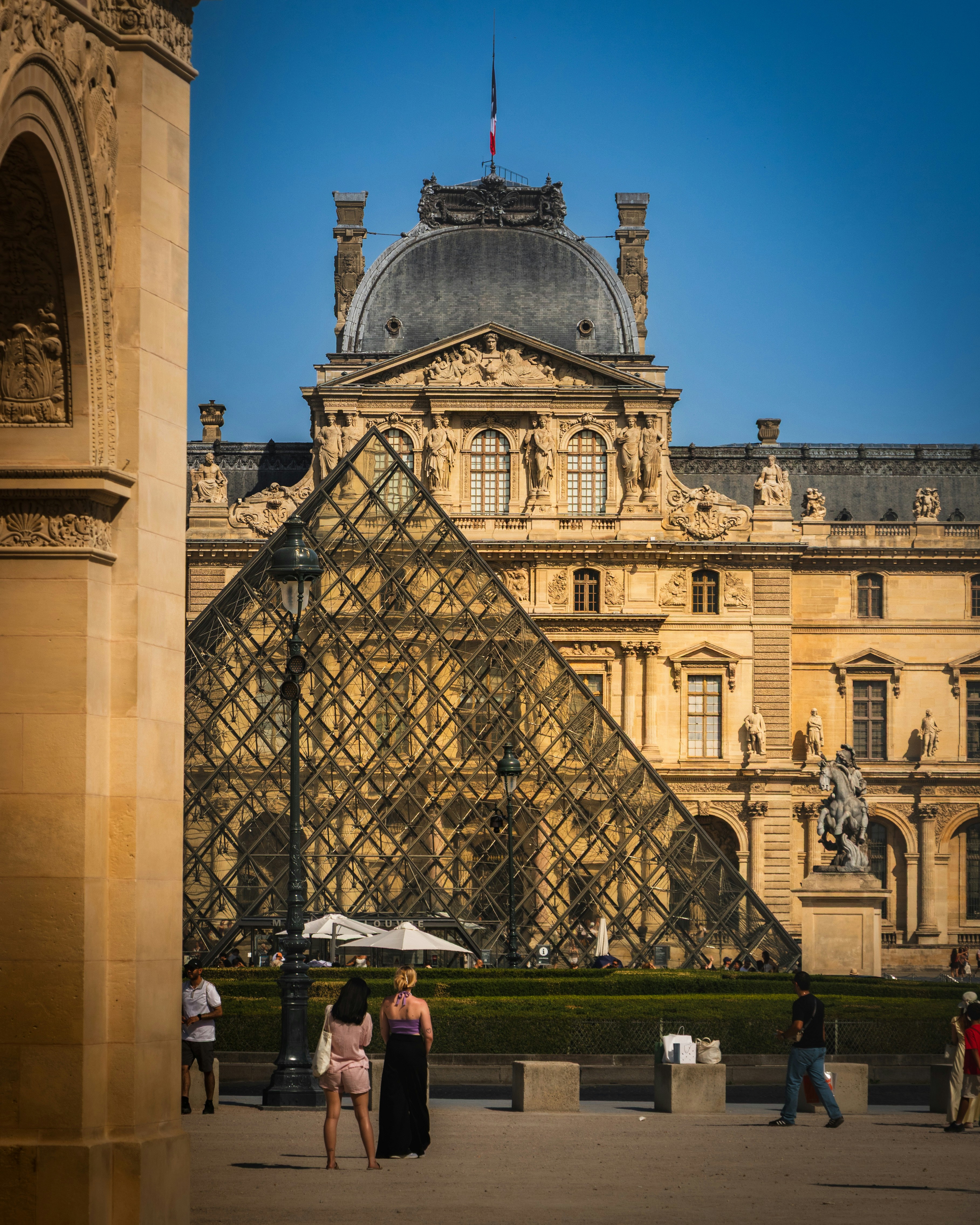 Geometric Echoes of Louvre: Glass Pyramid Framing a Classical Facade