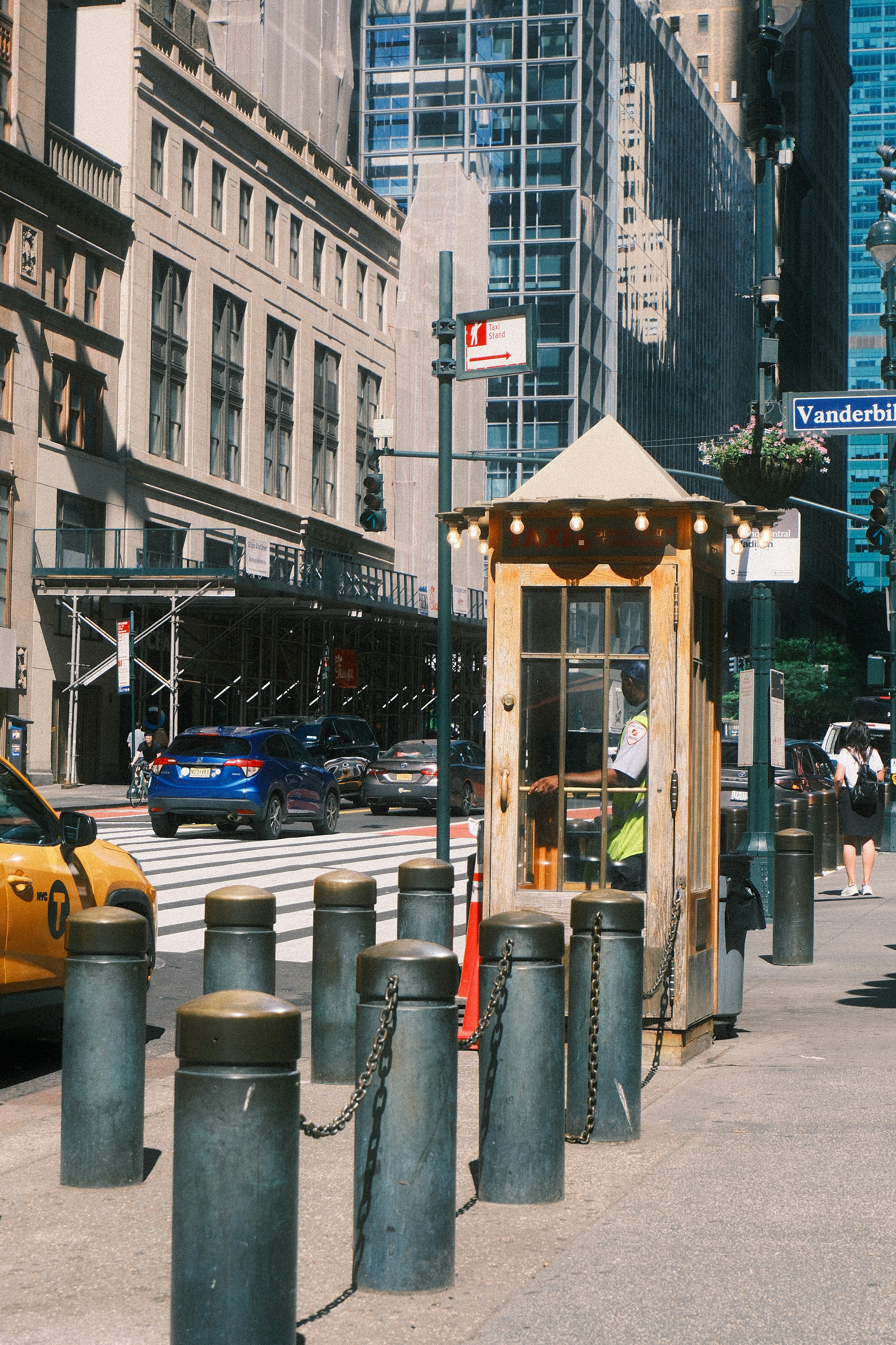 A small wooden booth on a bustling city street.
