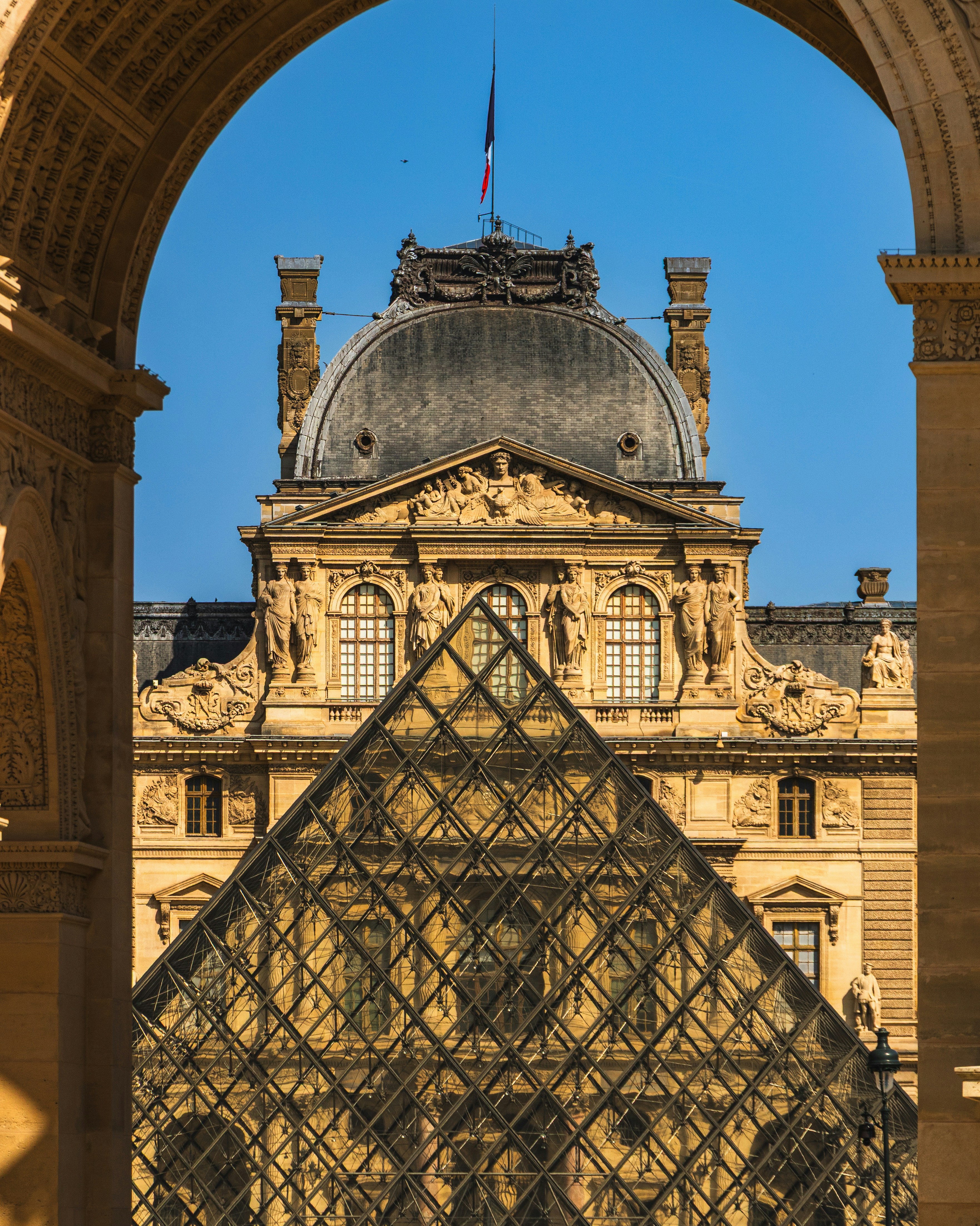 Crystal Angles: The Louvre Pyramid Framed by the Arc de Triomphe Arch