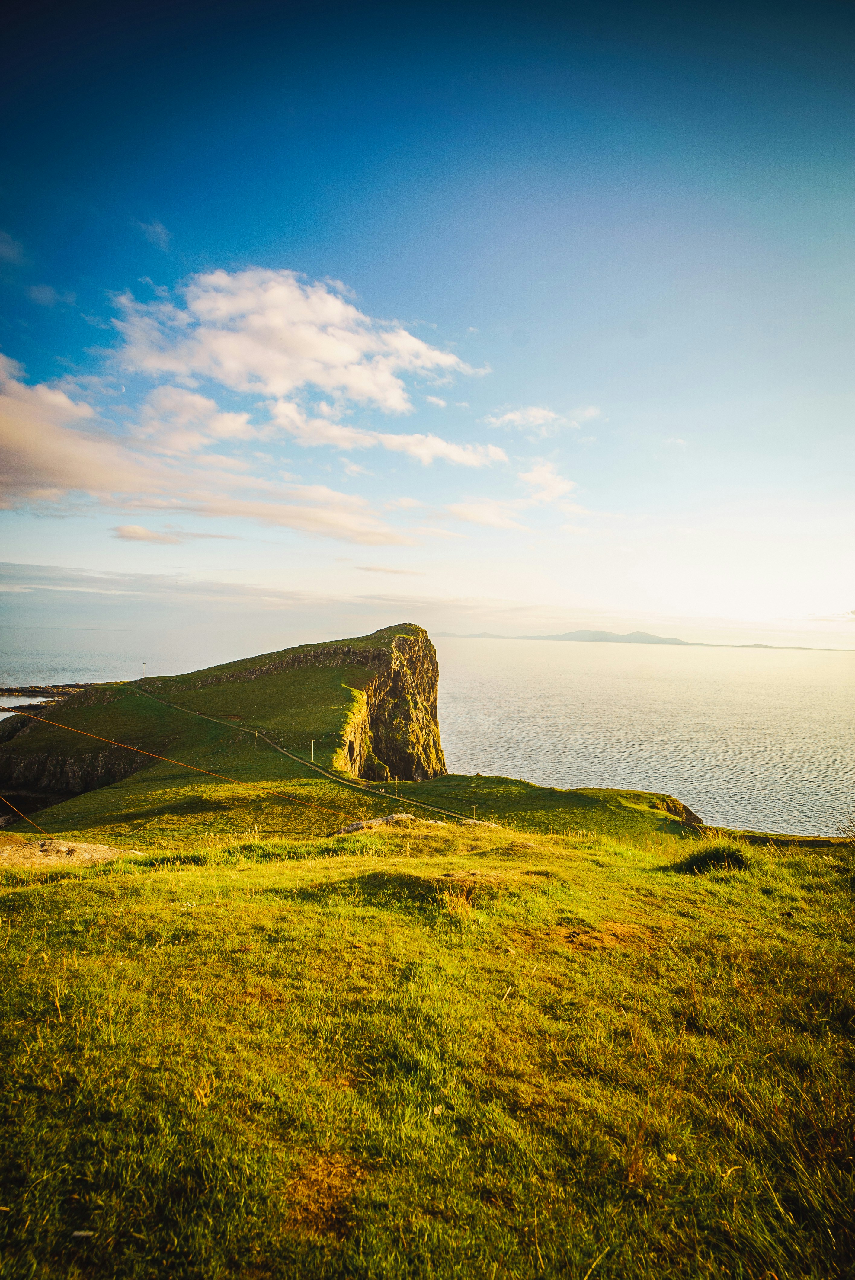 Cliff Edge on the Horizon: Golden Hillsmeet over the Sea
