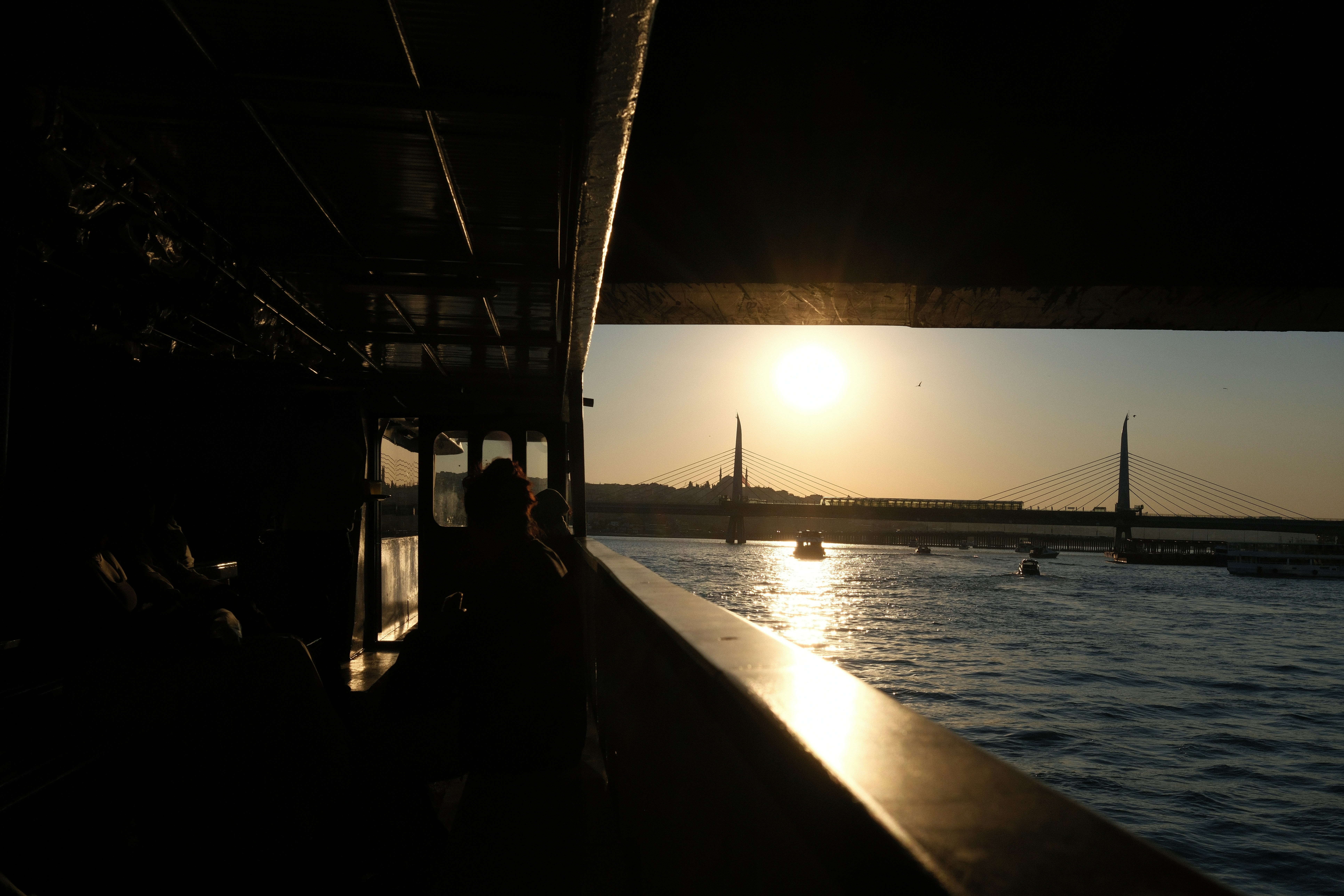 Sunlit Viaduct Over Water: Daylight Silhouette on a Harbourside Rail
