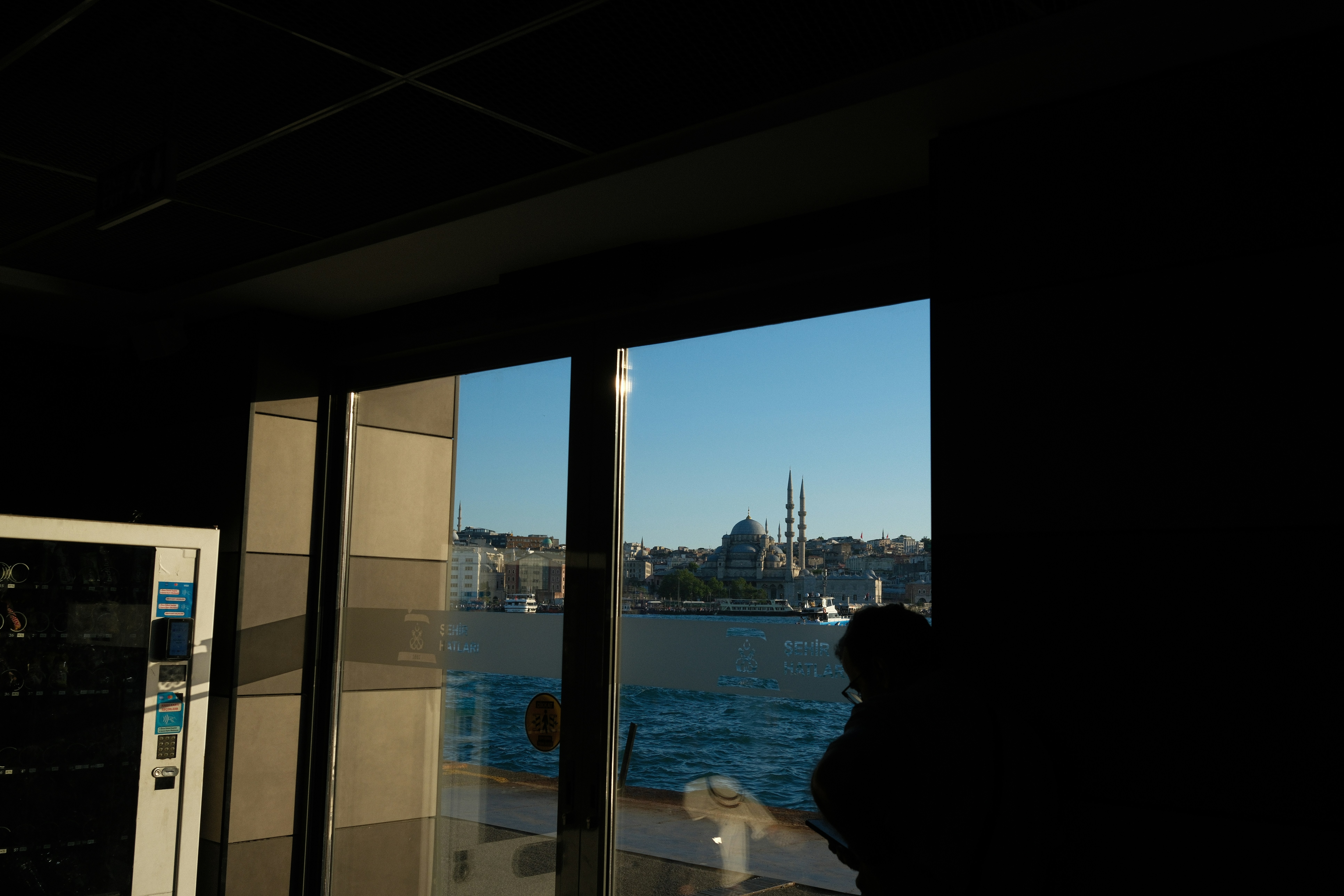 Sunlit City View Through a Dark Interior