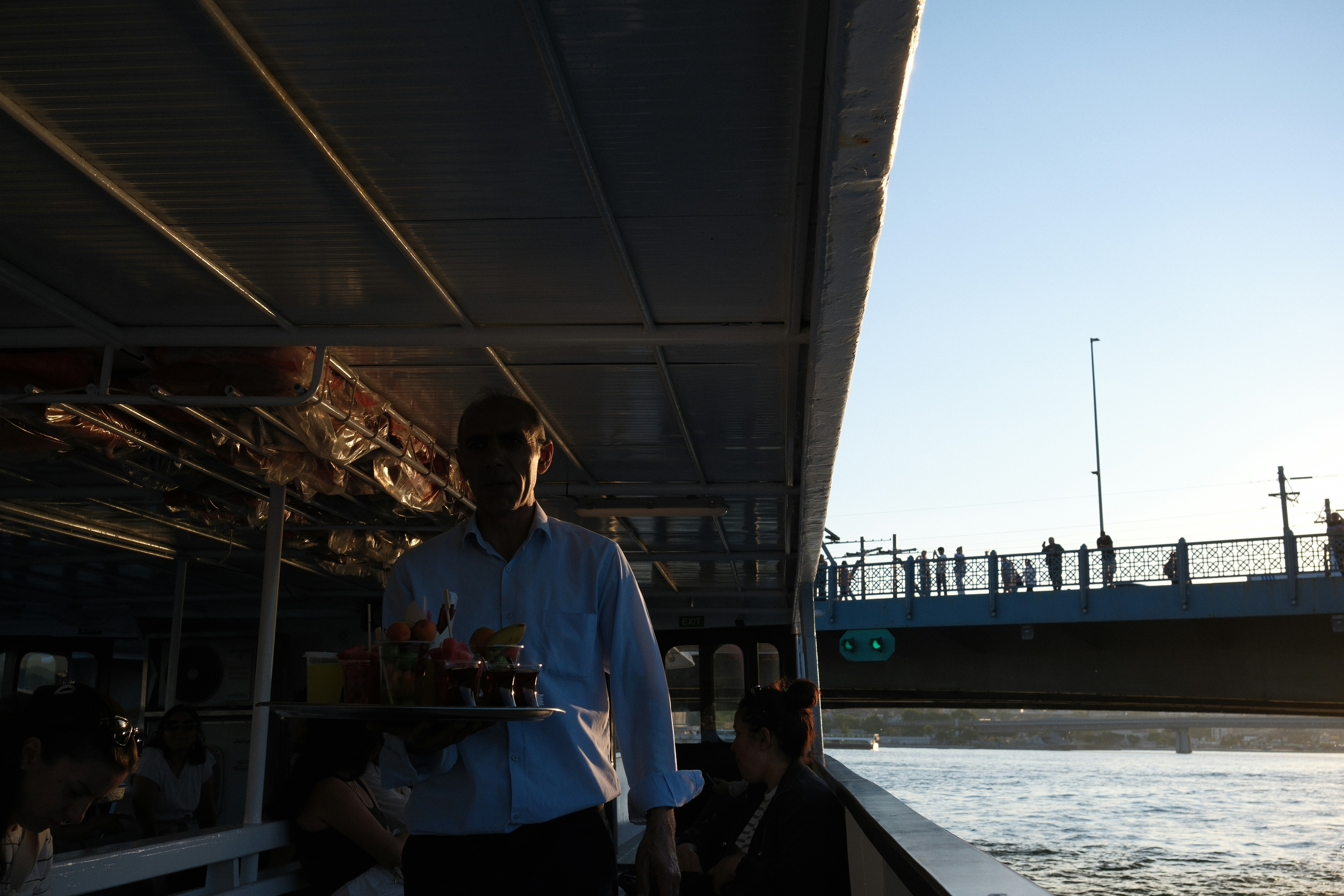 Evening Deck Service on a Waterfront Ferry