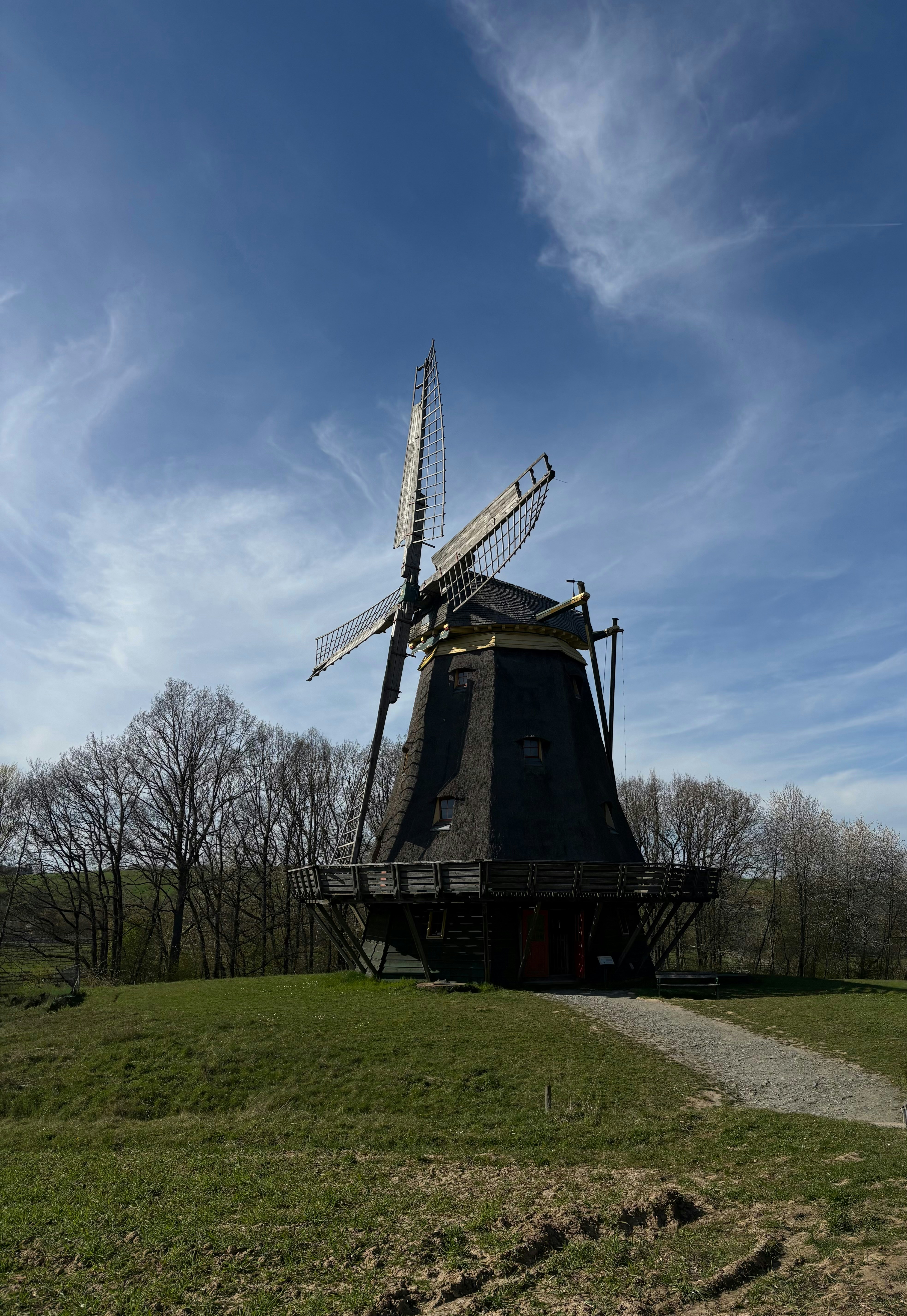 Low Sun, High Structure: A Historic Windmill Standing Against a Wide Sky