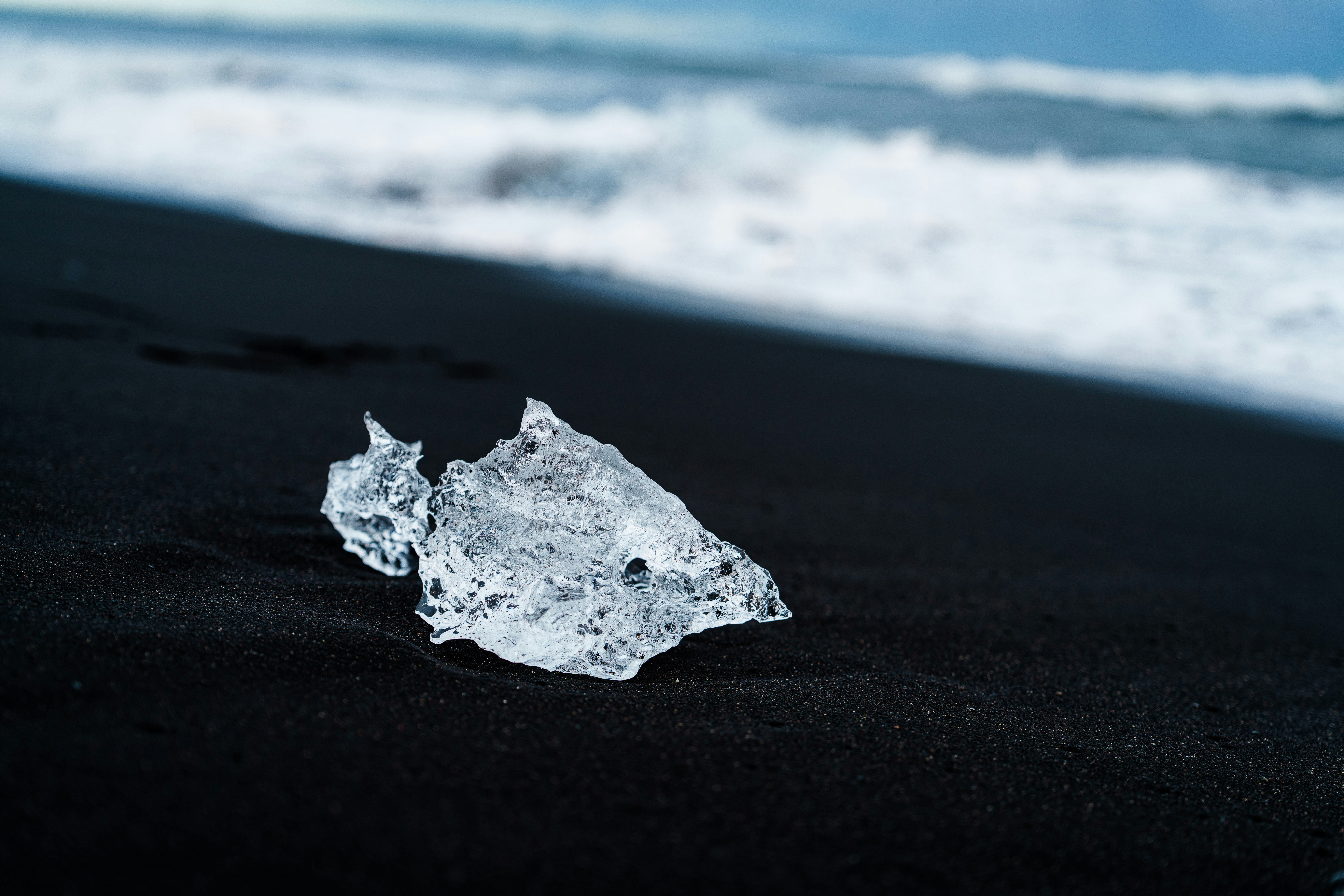 Ice Fragment on Charcoal Shore at Dusk