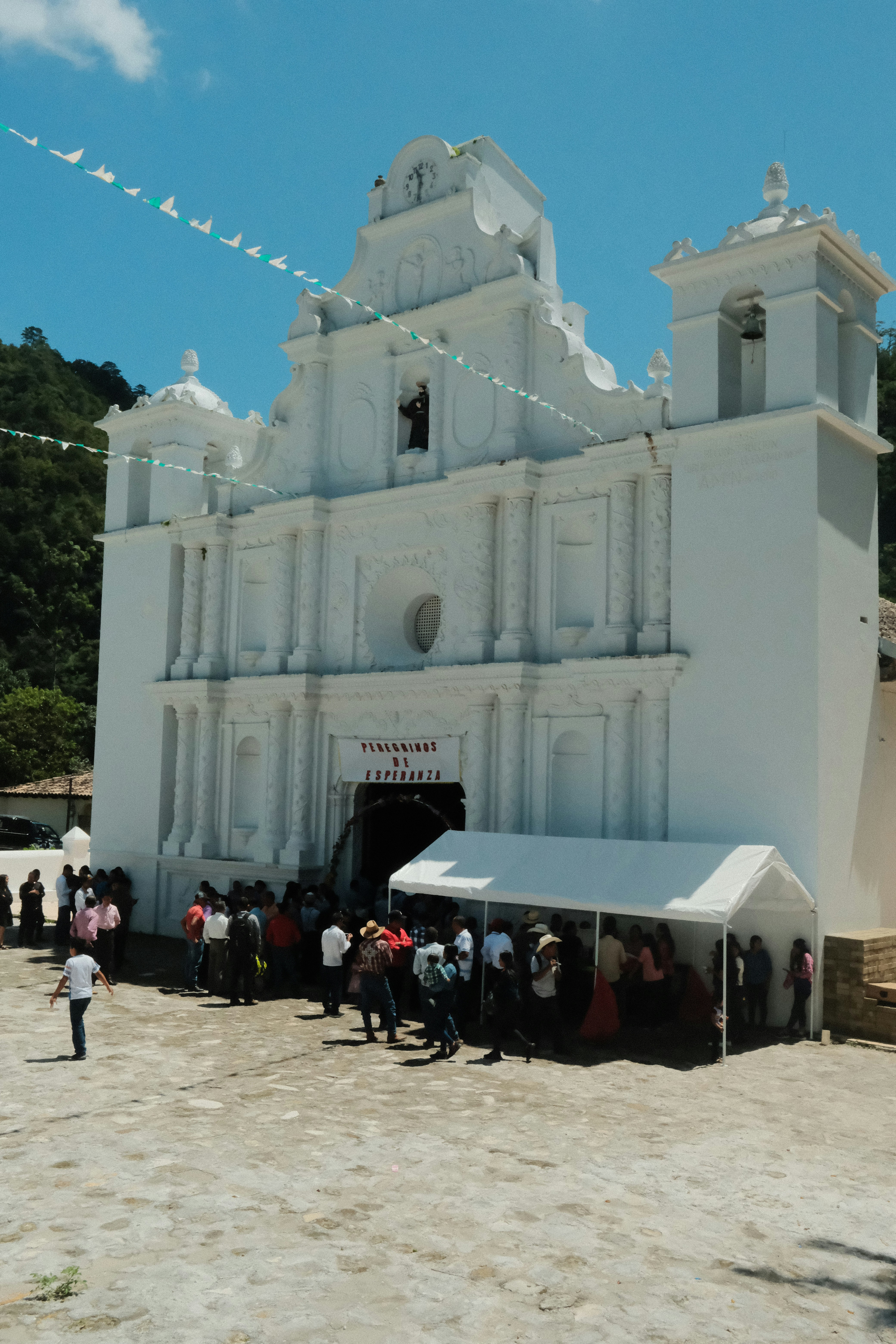 Solemn White Facade: A Church Summit Under a Blue Sky