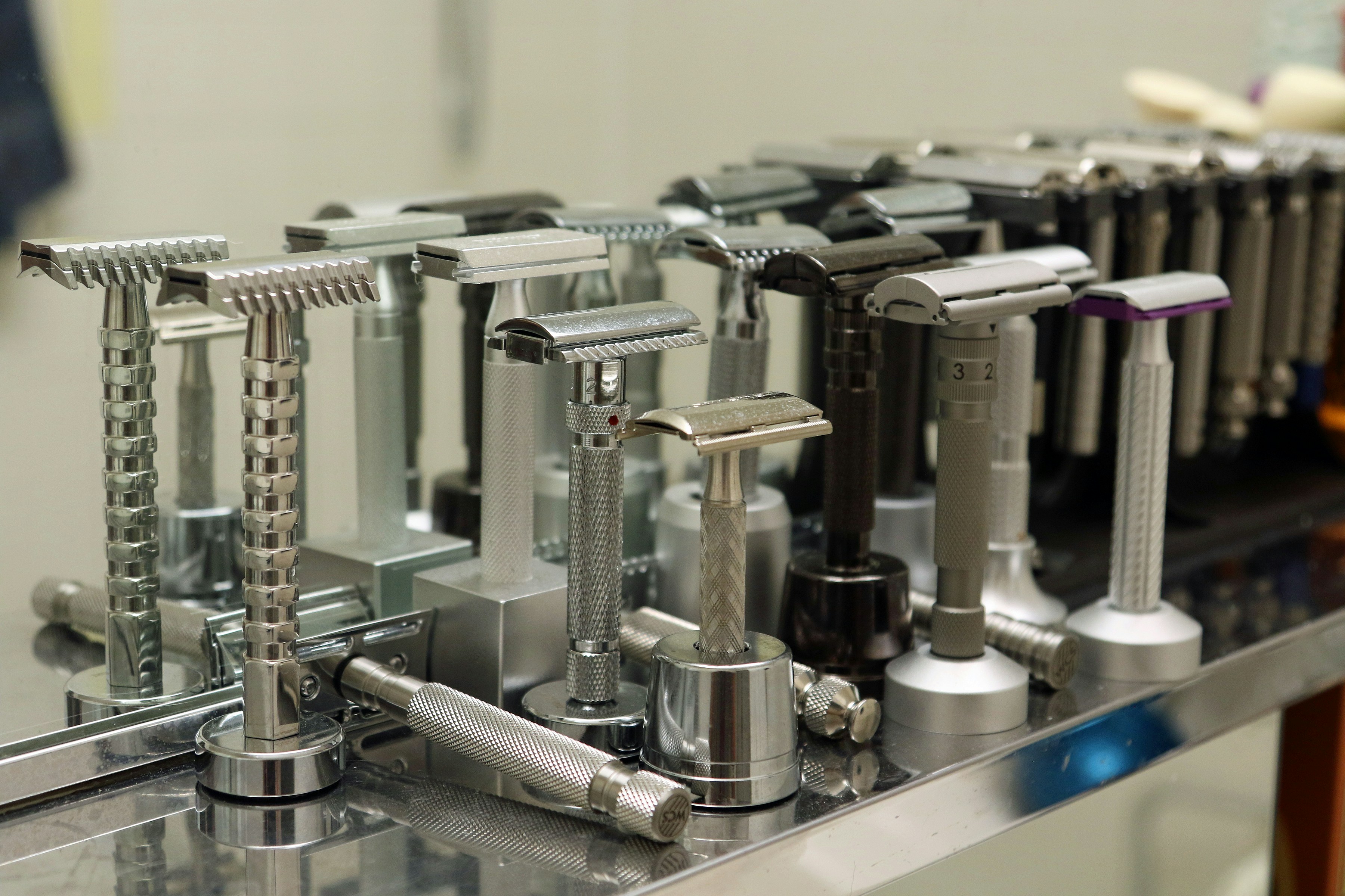 Precision in Steel: A Row of Classic Safety Razors on a Workbench