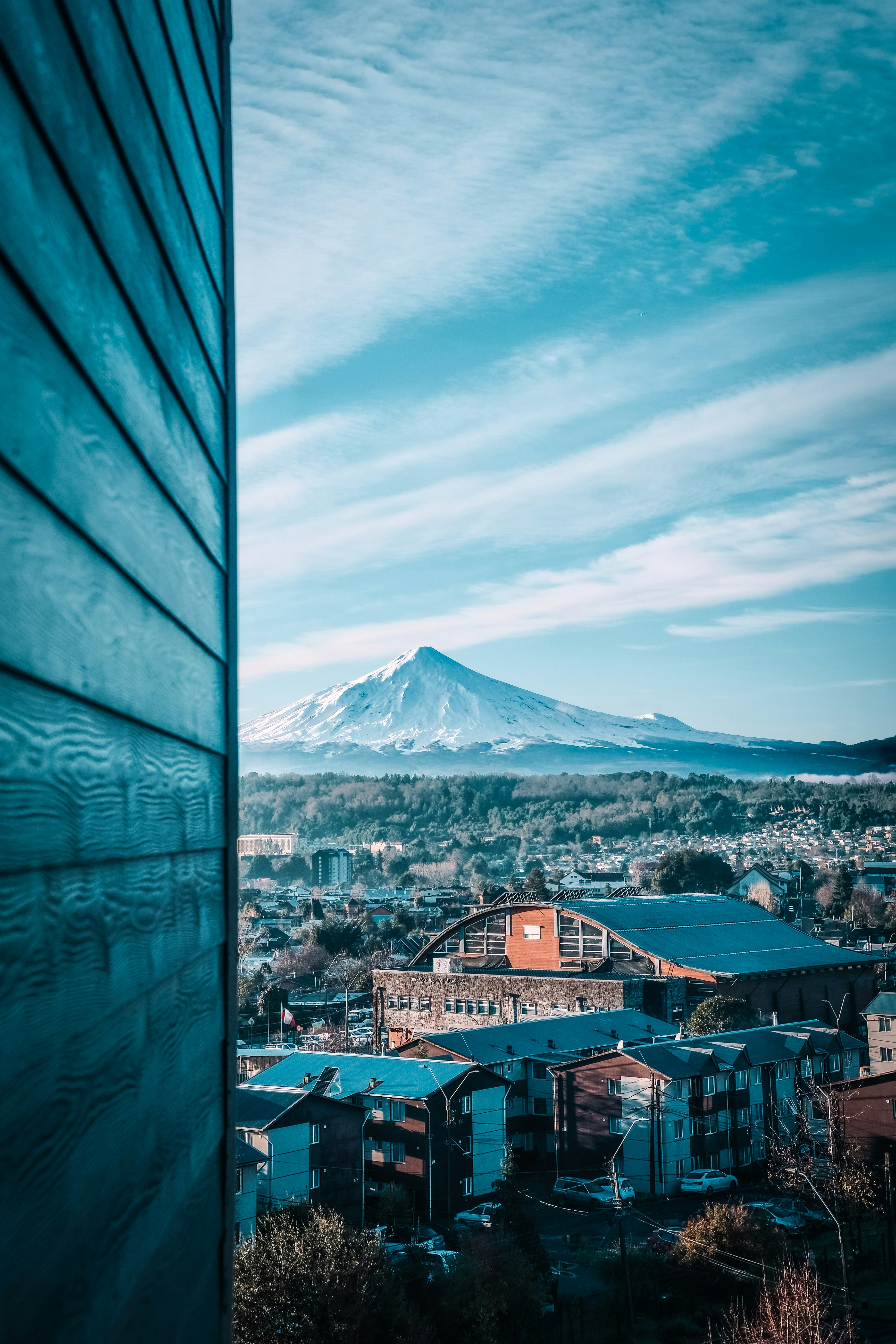 Edge of the City: Snow-Capped Peak Beyond the Rooftops
