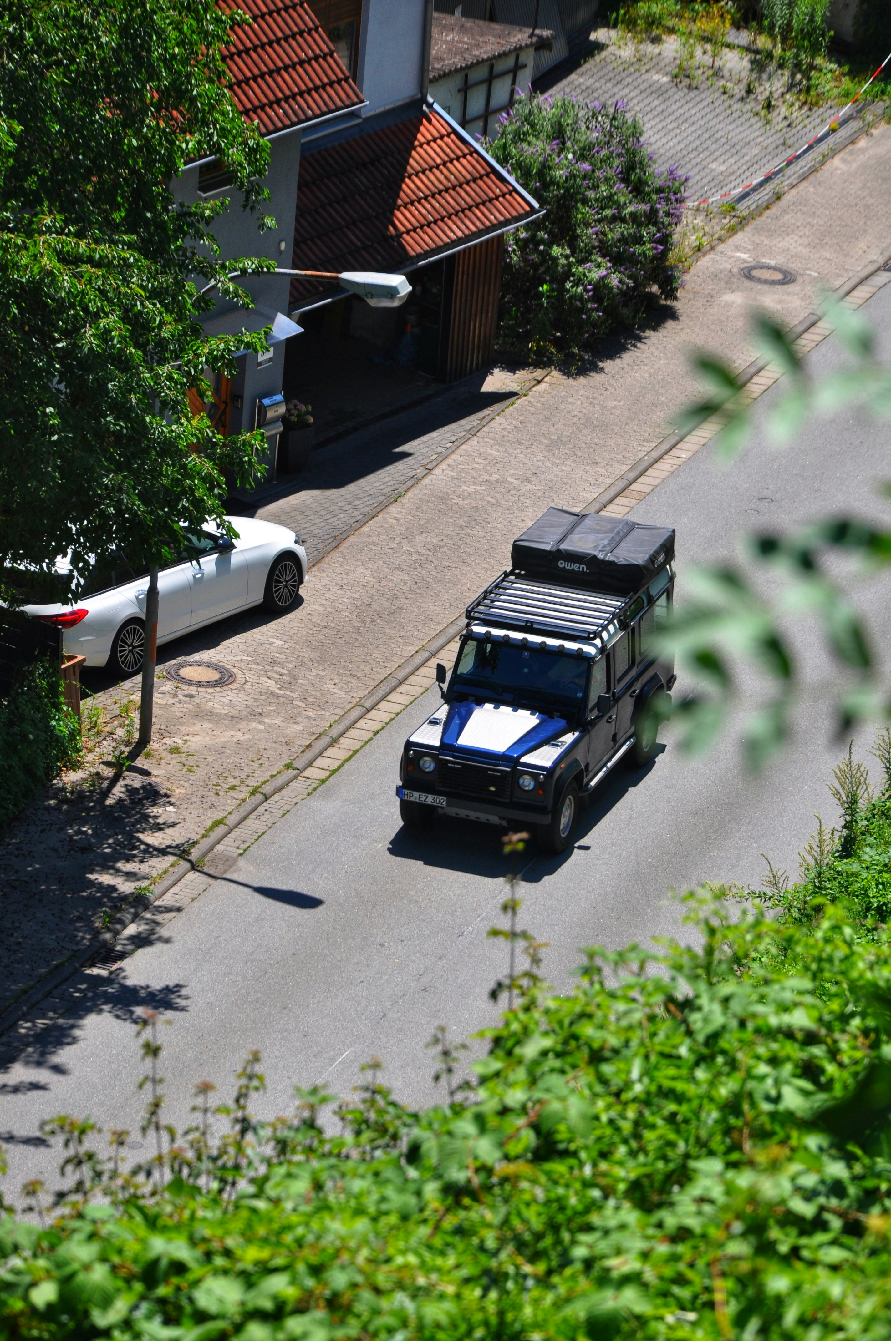 Rugged street trek: a compact off-road guardian rolls past a quiet European alley