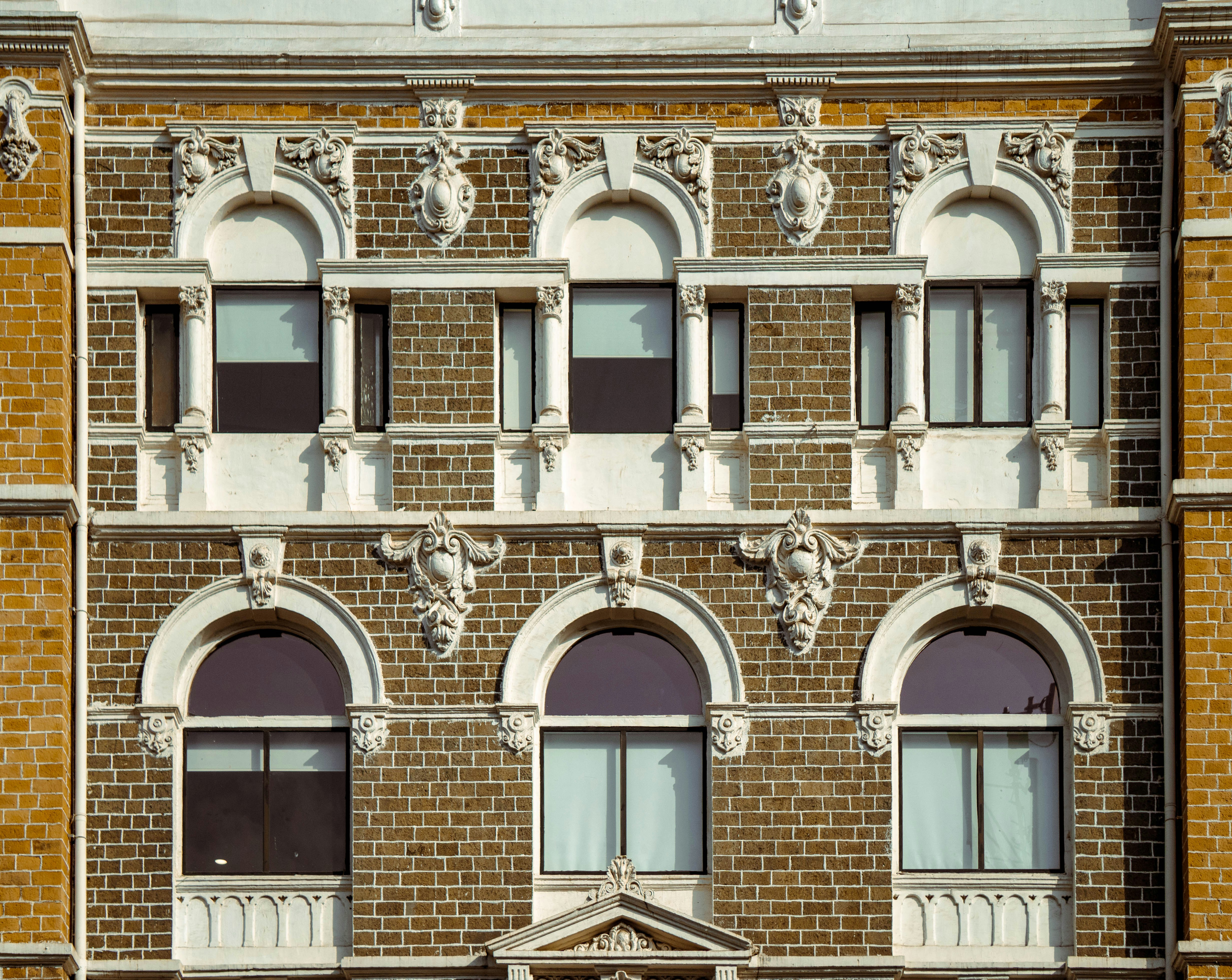 Ornate brick building facade with multiple arched windows.