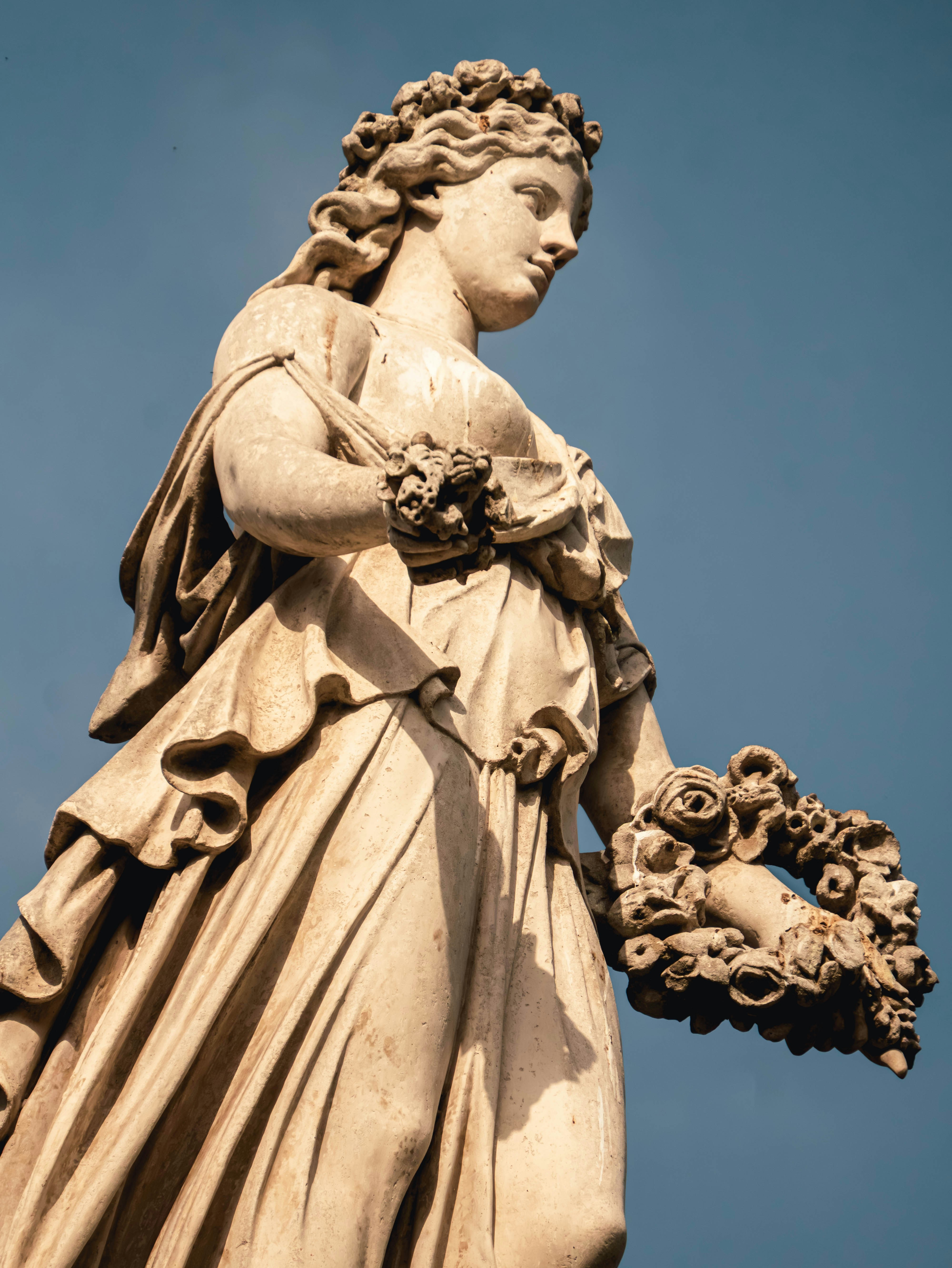 Statue in Soft Light: A Marble Goddess Gracing the Sky