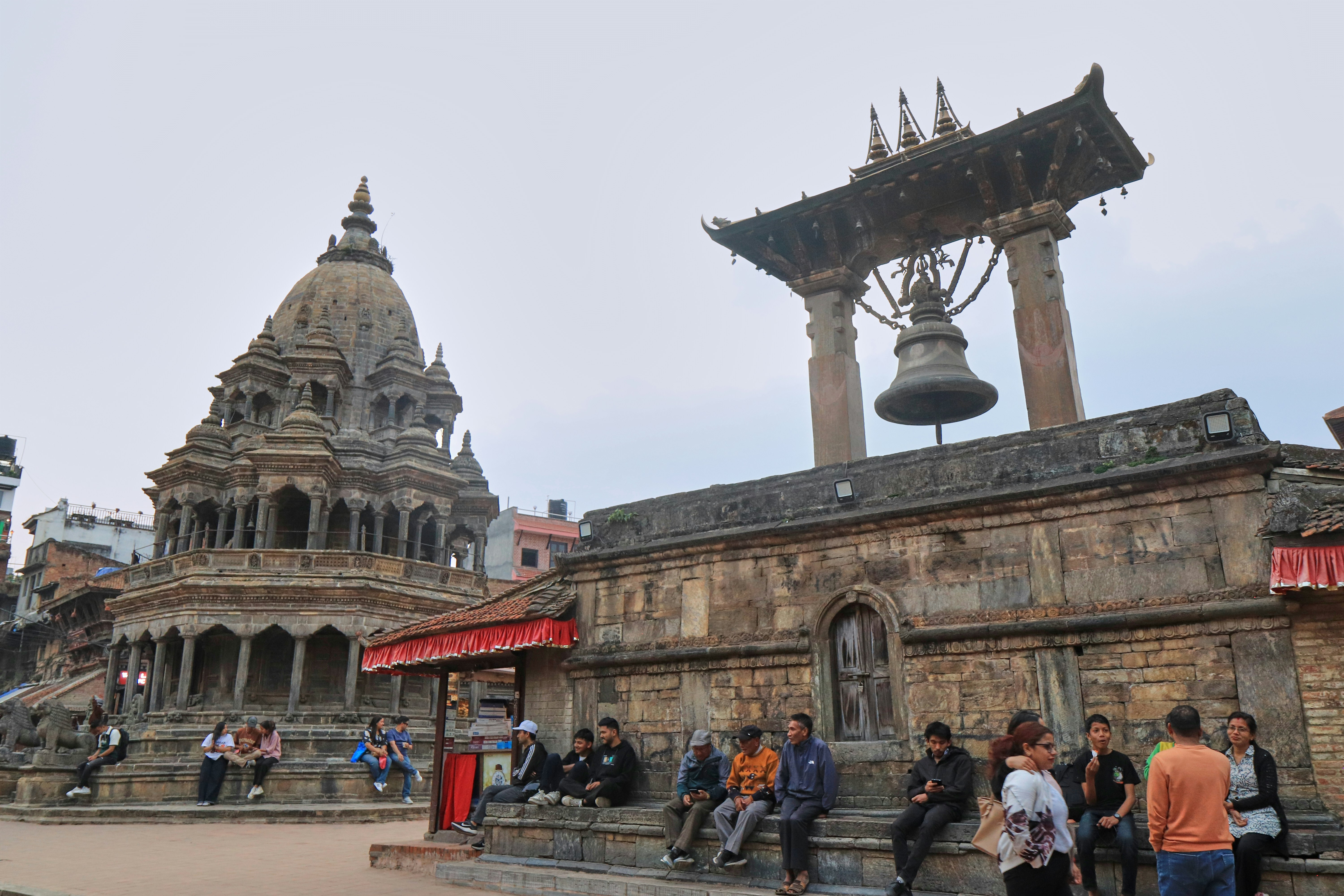 Temple Bell and Arcaded Steps: Life Beneath the Dvarapala Towers