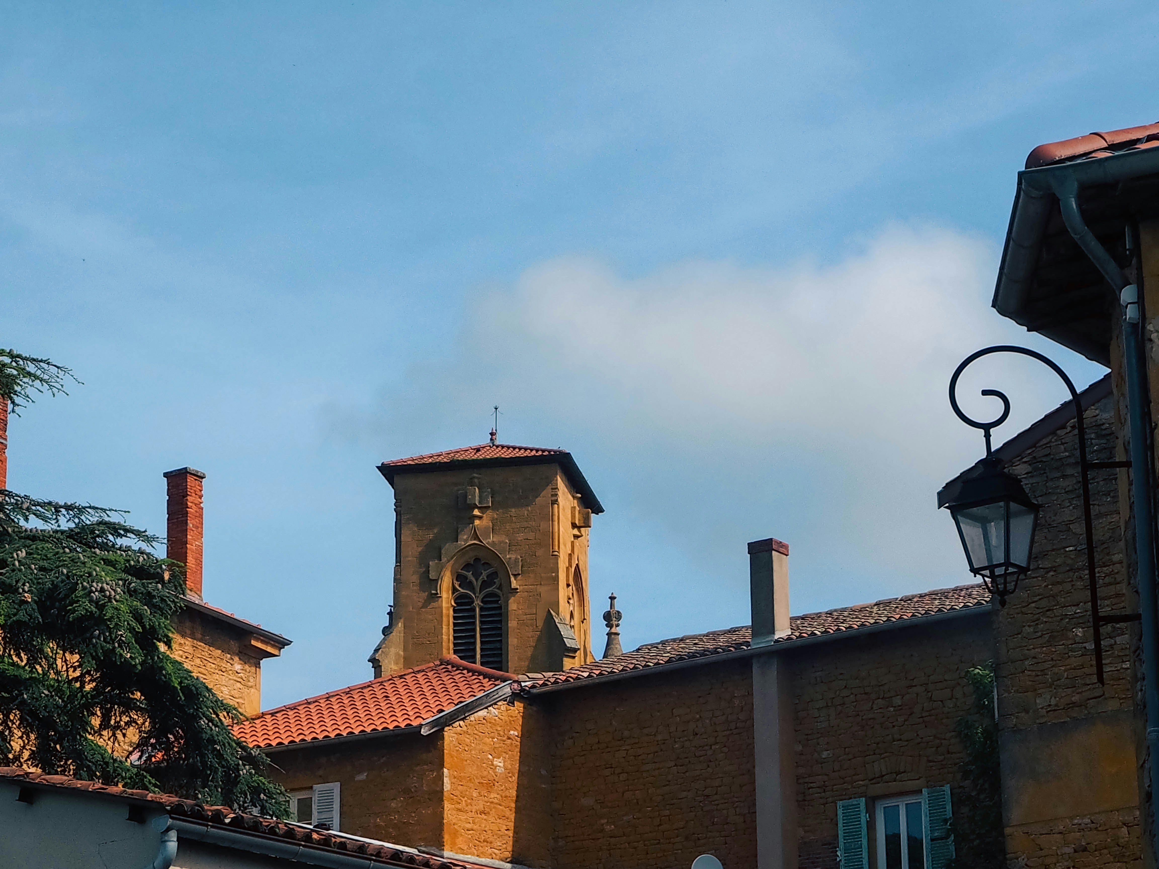 Tuscan Rooftops and Bell Tower Under a Clear Sky