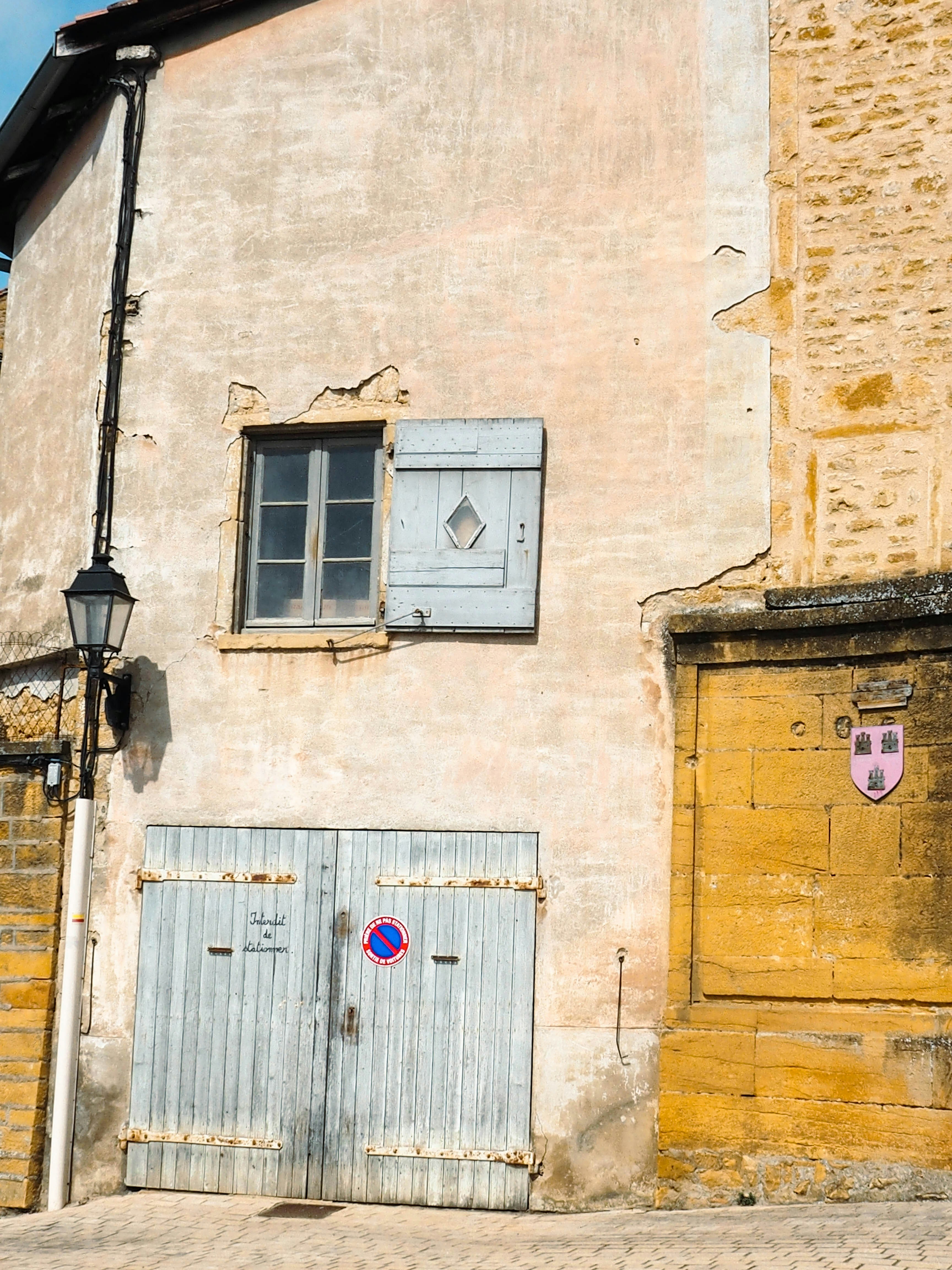 Weathered Facade and Pale Blue Shutters