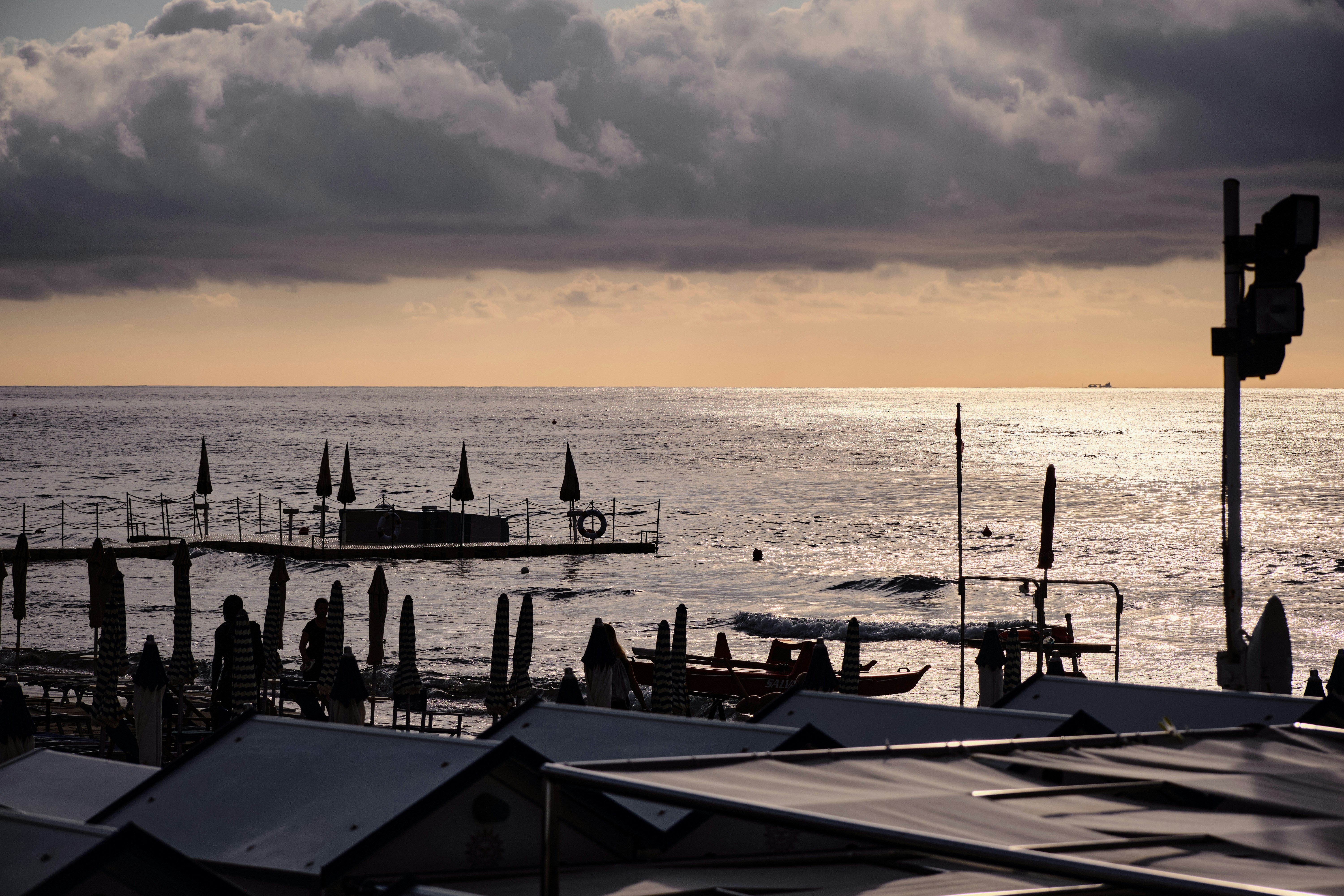 Quiet shoreline silhouettes under a harbor of sunset