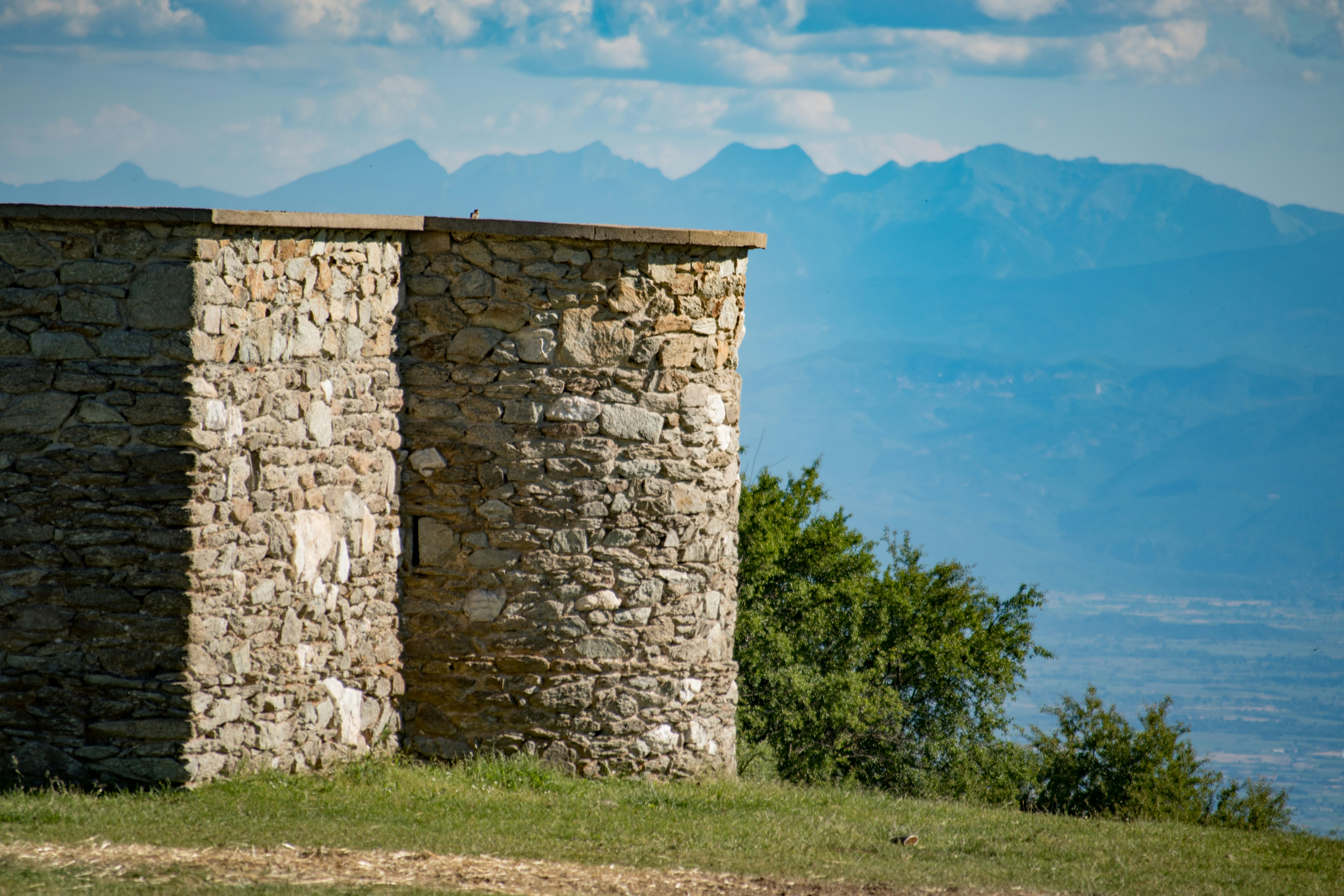 Stone Construct in a Mountain Valley with Distant Peaks
