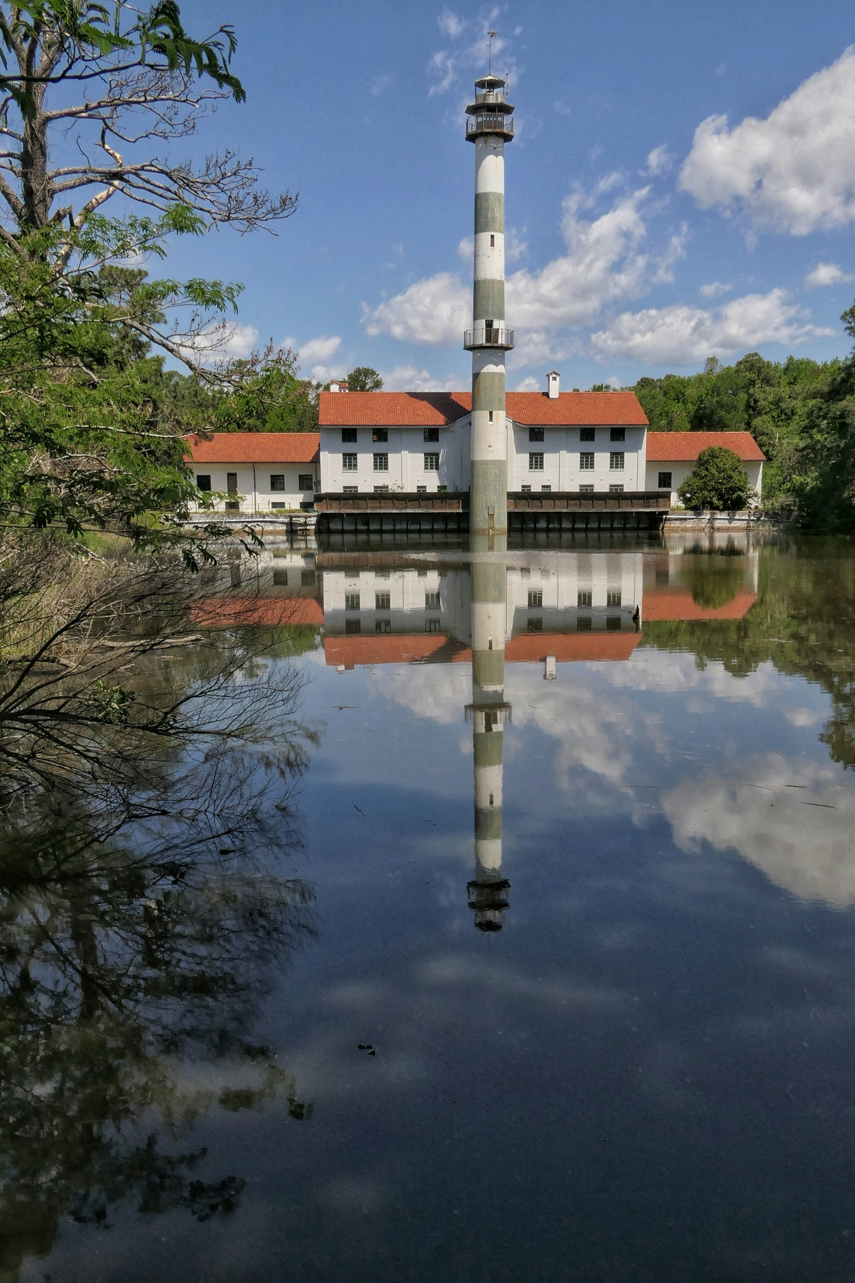 Twin Reflections: A Lighthouse Studio Cast in Quiet Waters