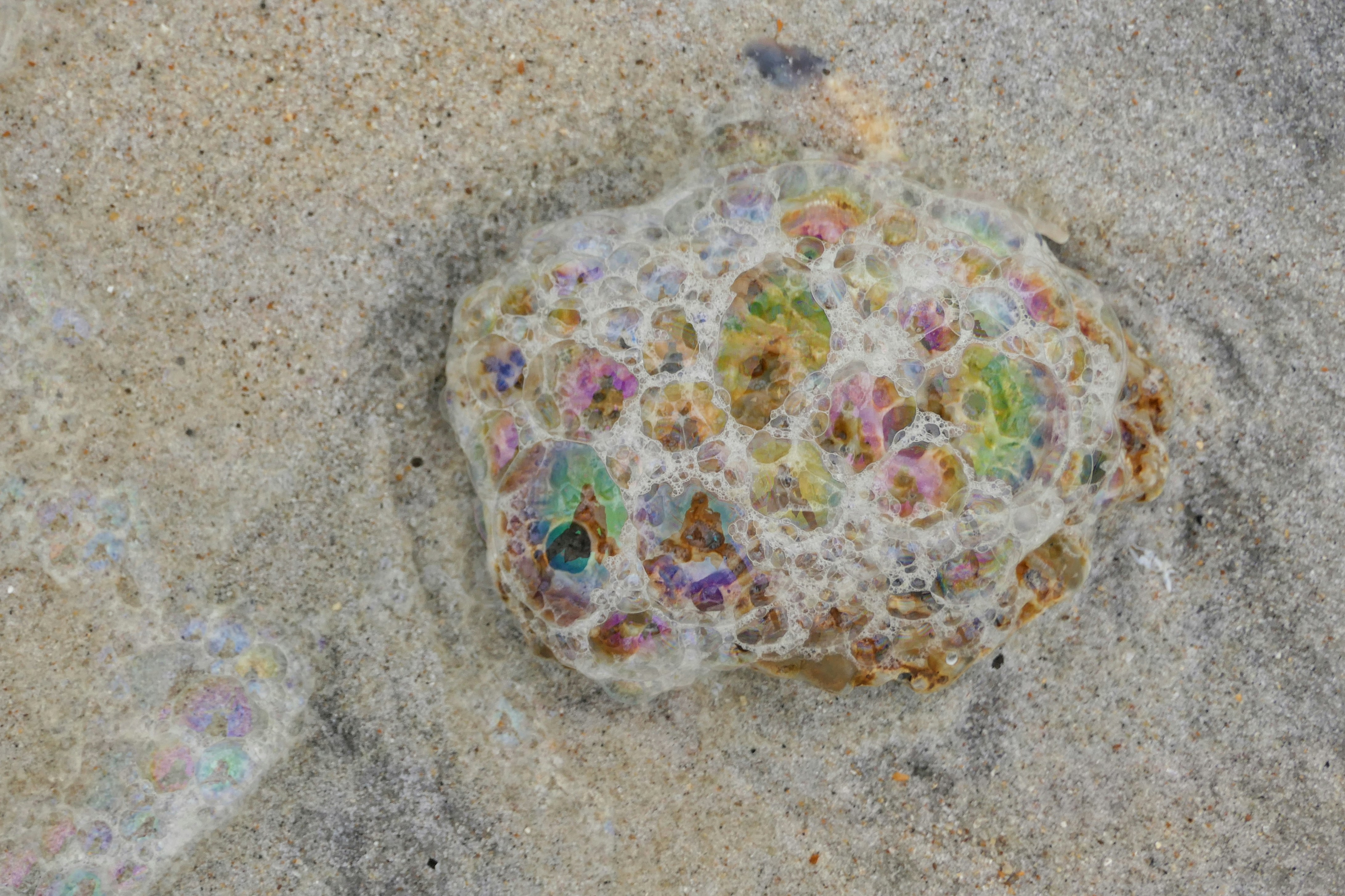 Colorful Bubble-Covered Rock on Sandy Shore