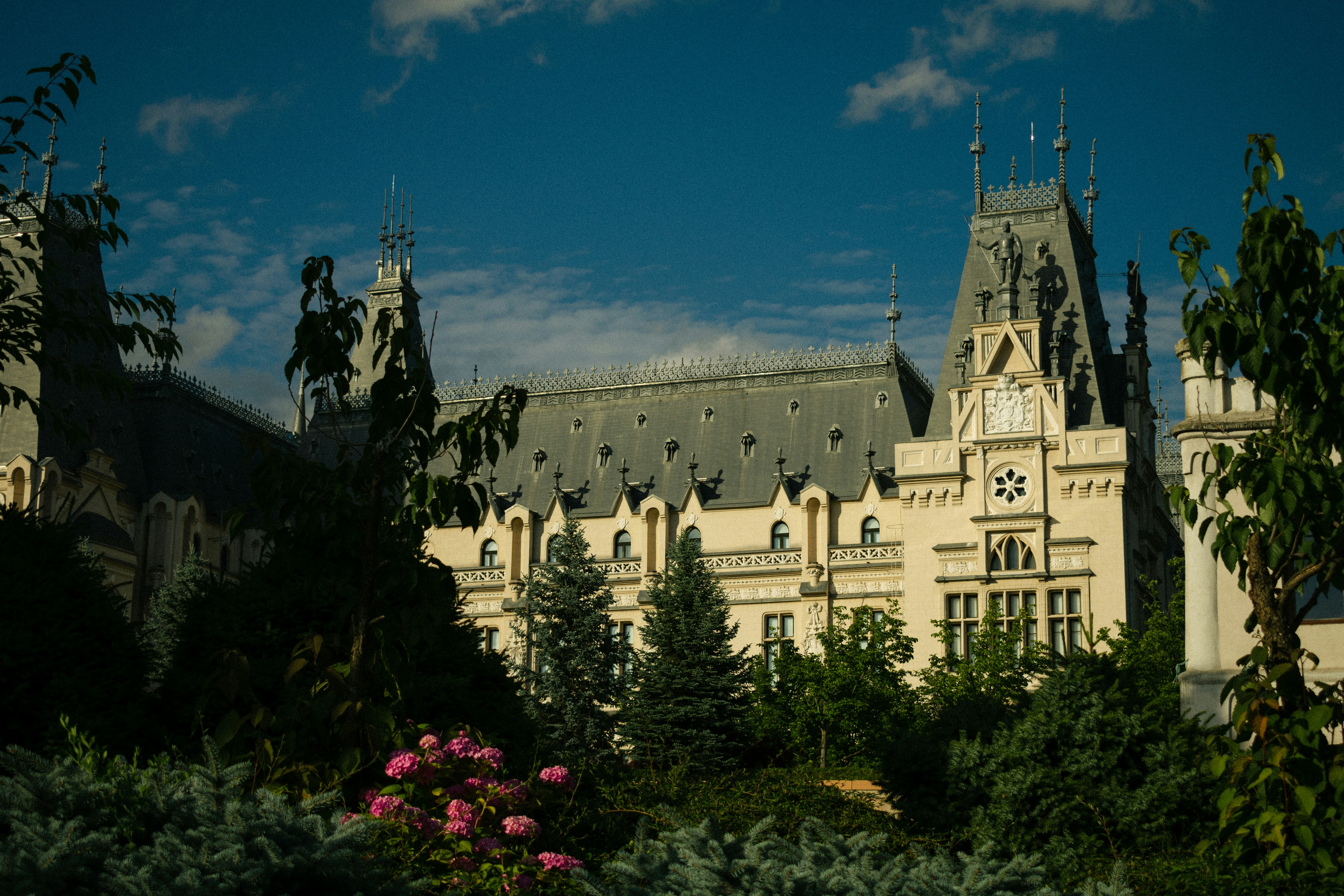 Gothic Campus Facade Rising Beyond a Lush Foreground