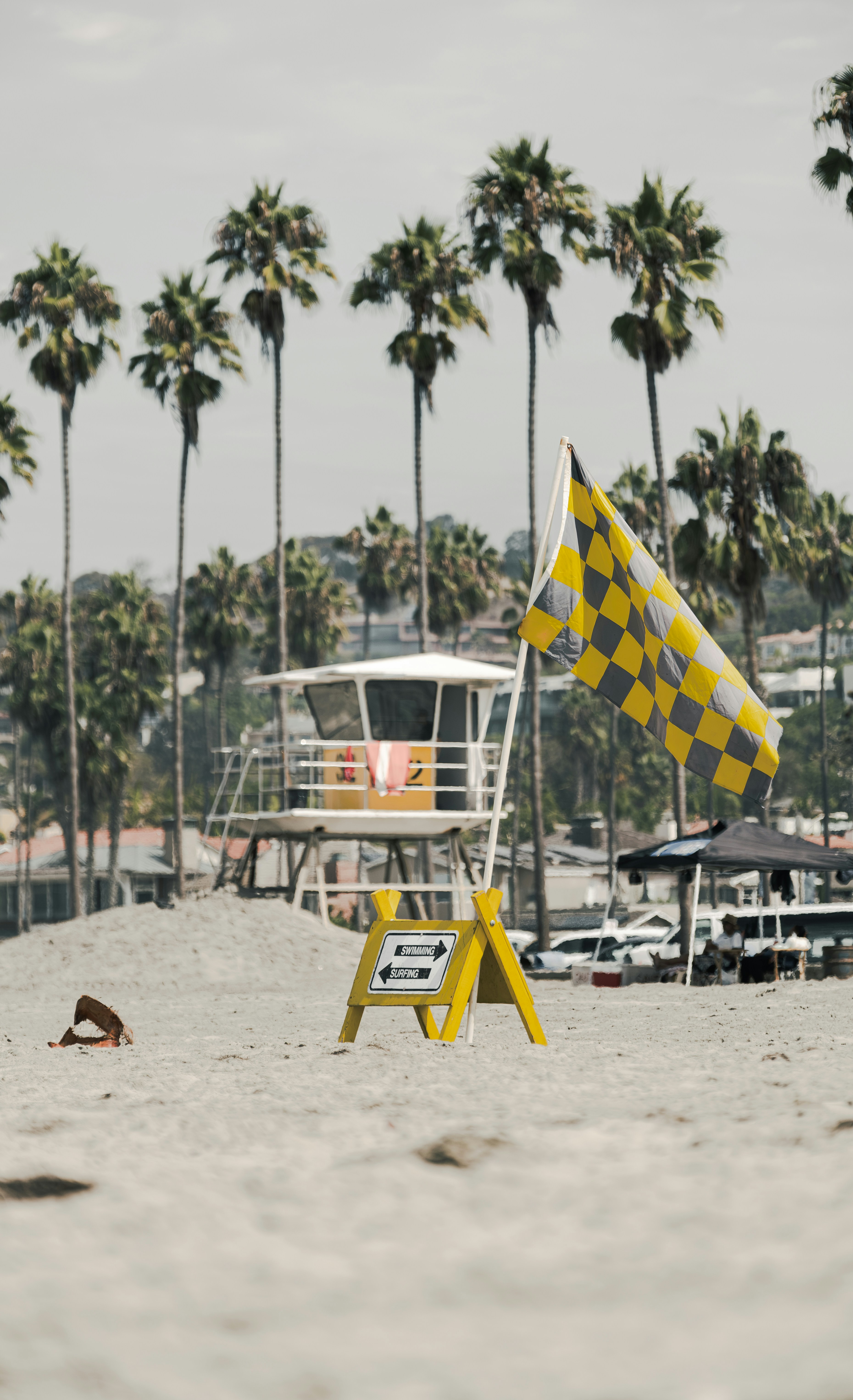 Lifeguard Tower and Yellow-Flag Cornered by a Bold Checkered Flag