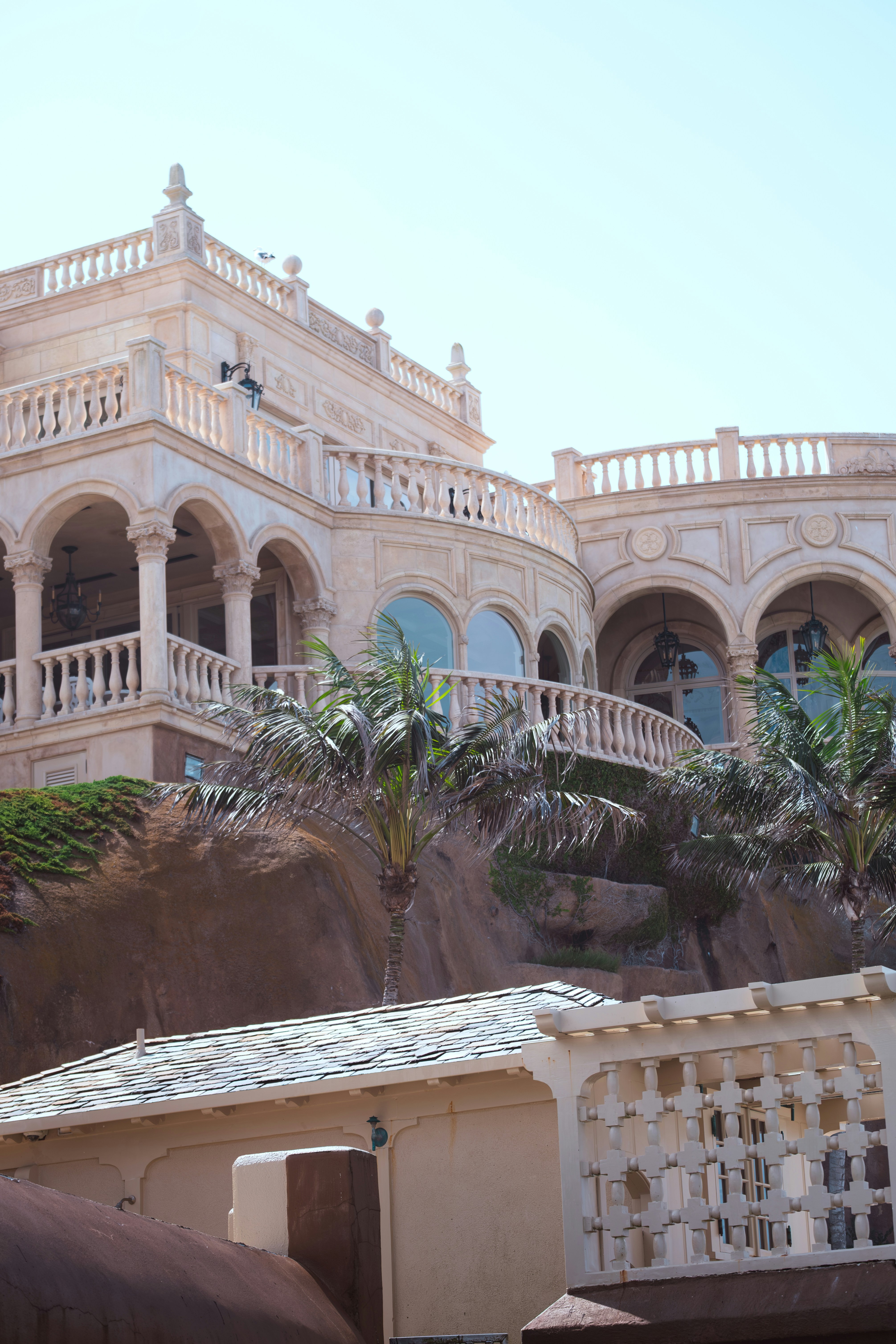 Terraced villa by the sea: sunlit arches and palm silhouettes