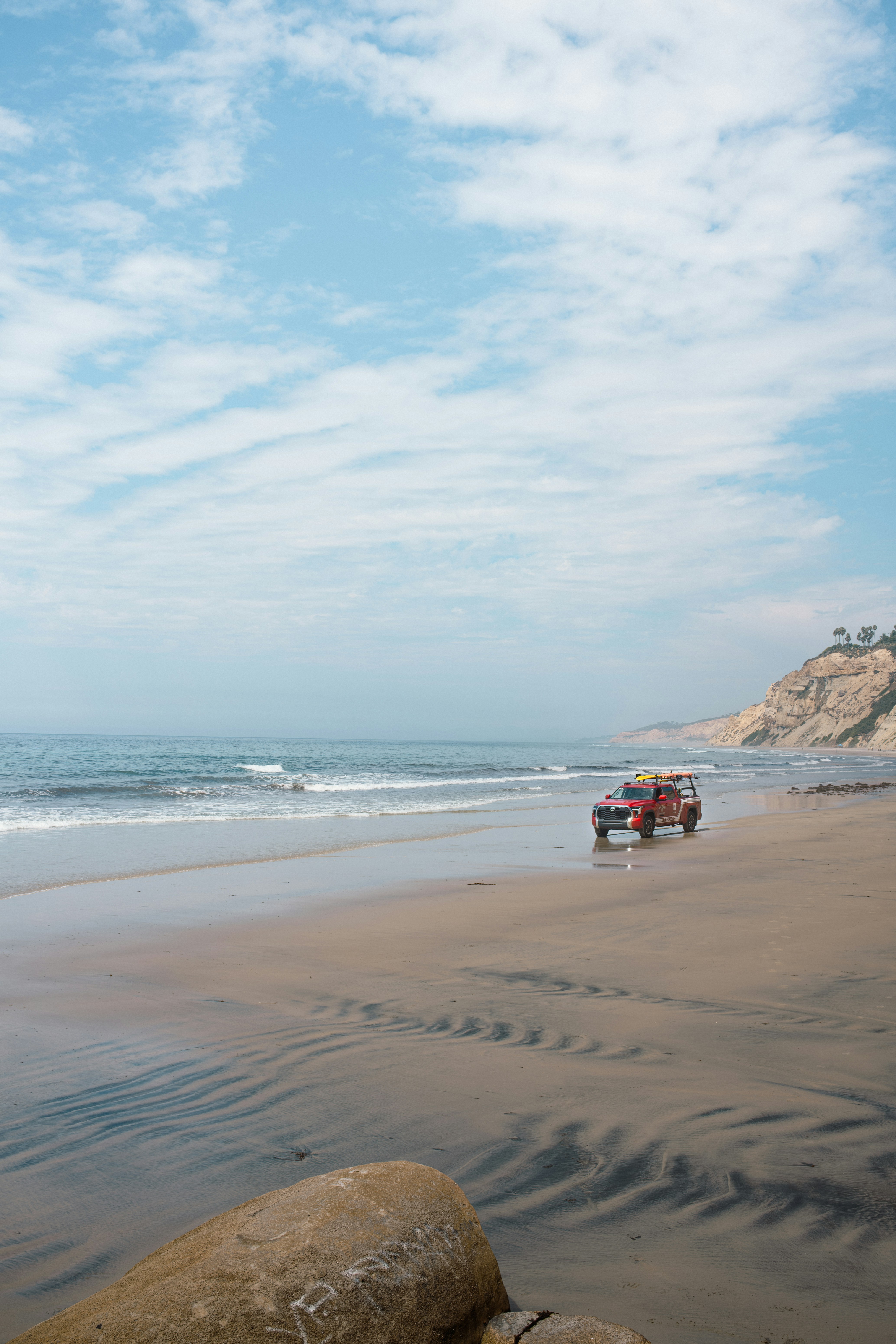 Red Jeep on a Quiet Seaside Road