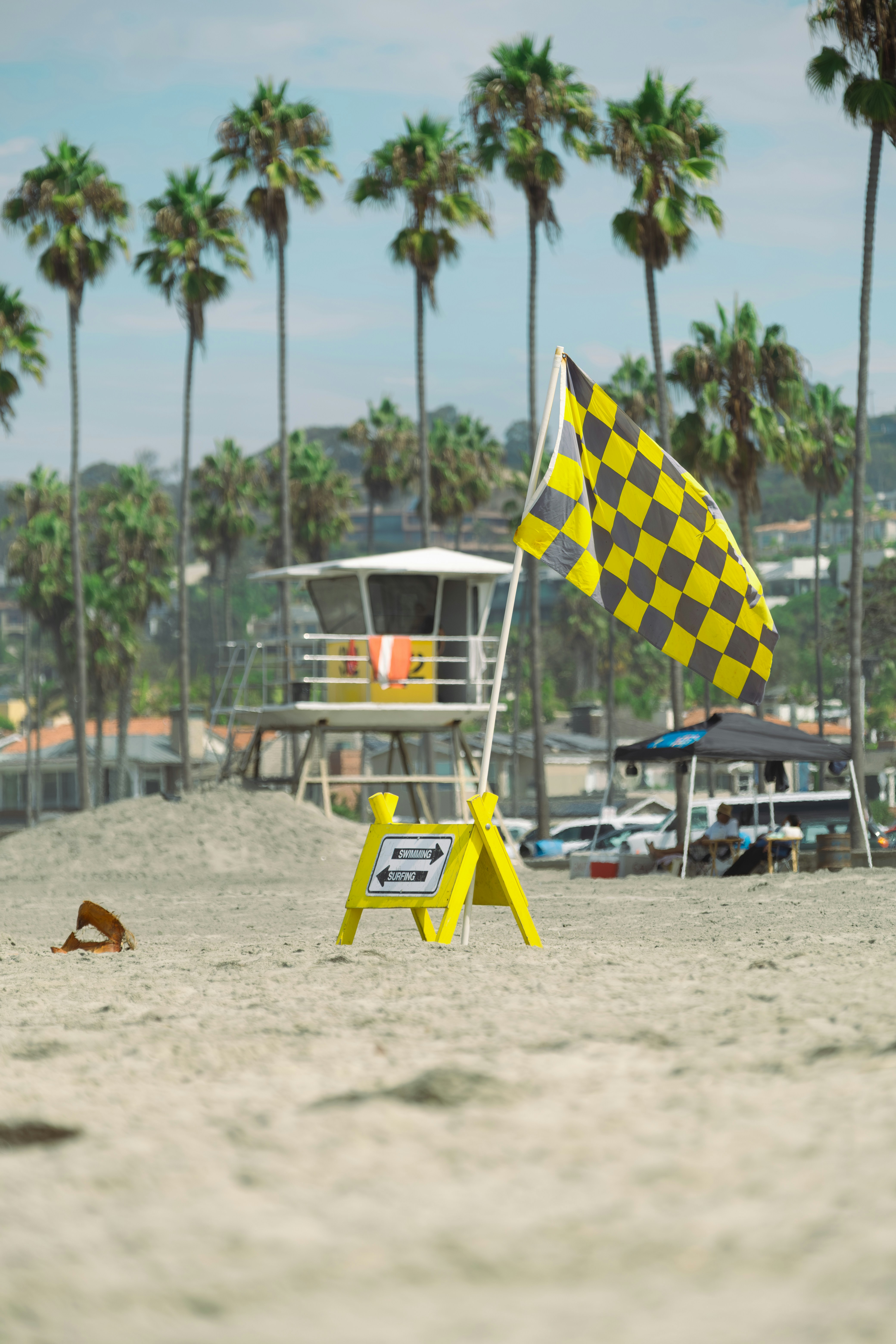 Checkerboard Flag at the Beach: A Quiet Hour by the Lifeguard Tower