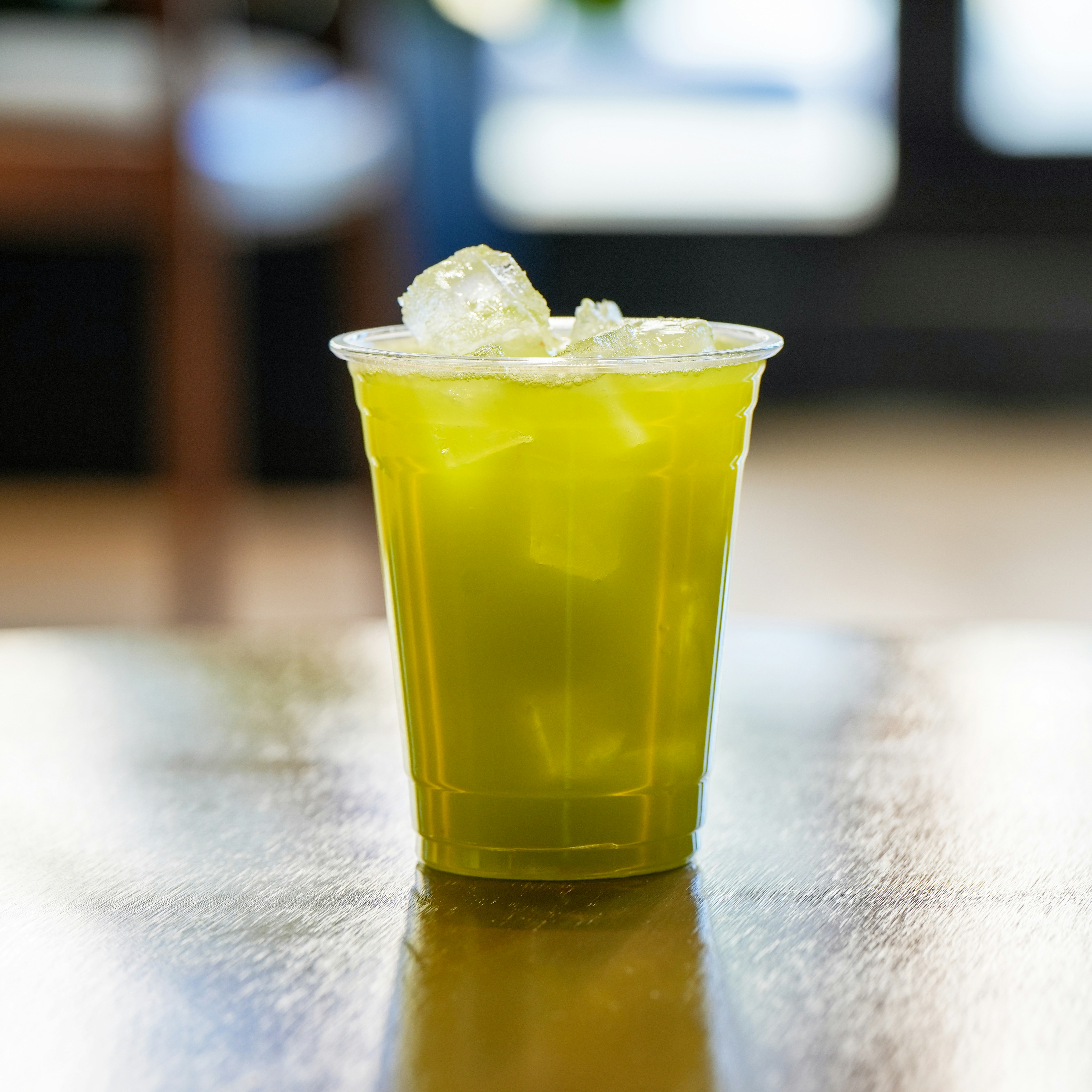 Citrus Glow: Ice-cold Green Lemonade on a Sunlit Table