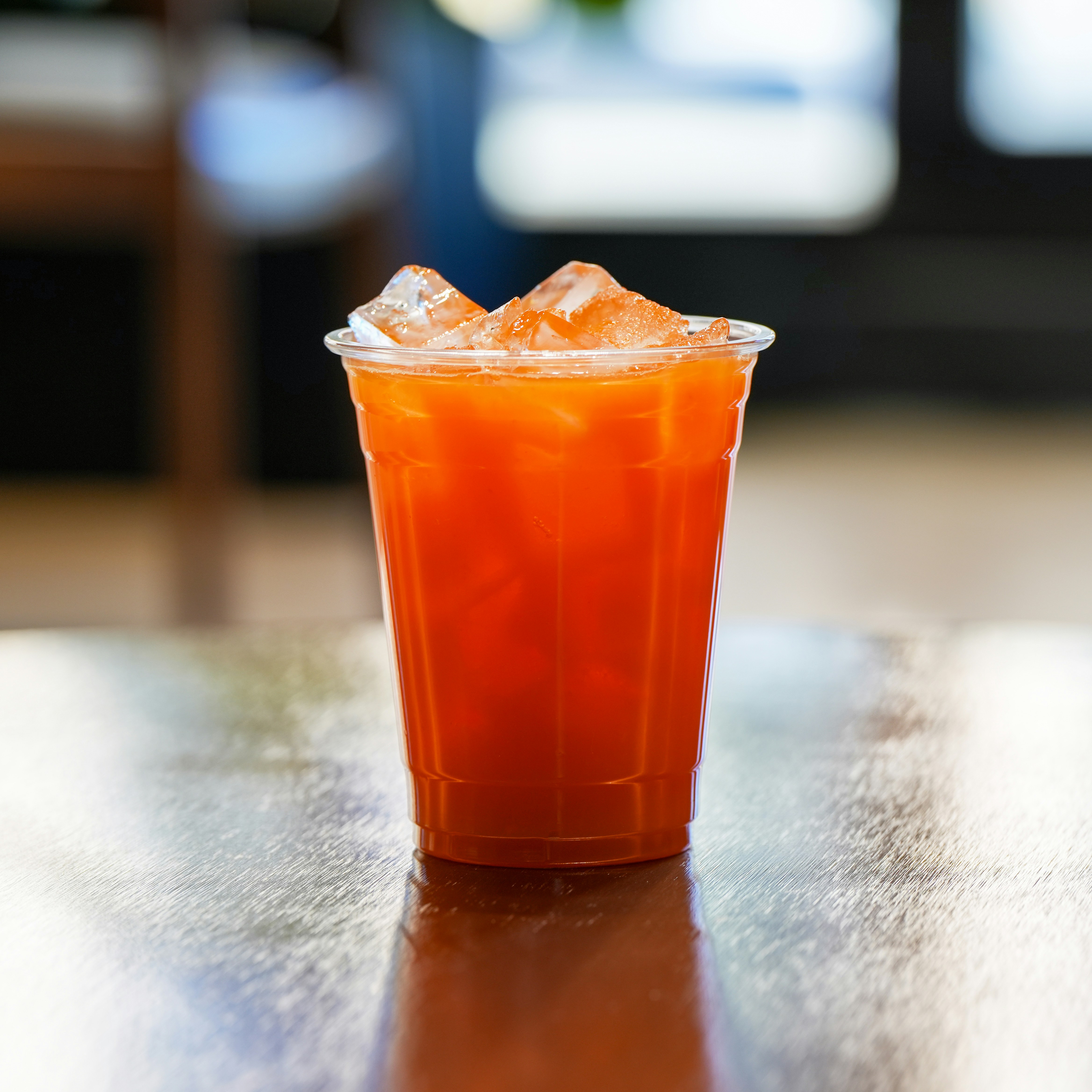 Citrus Sunset: Iced Drink Perched on a Sunlit Table