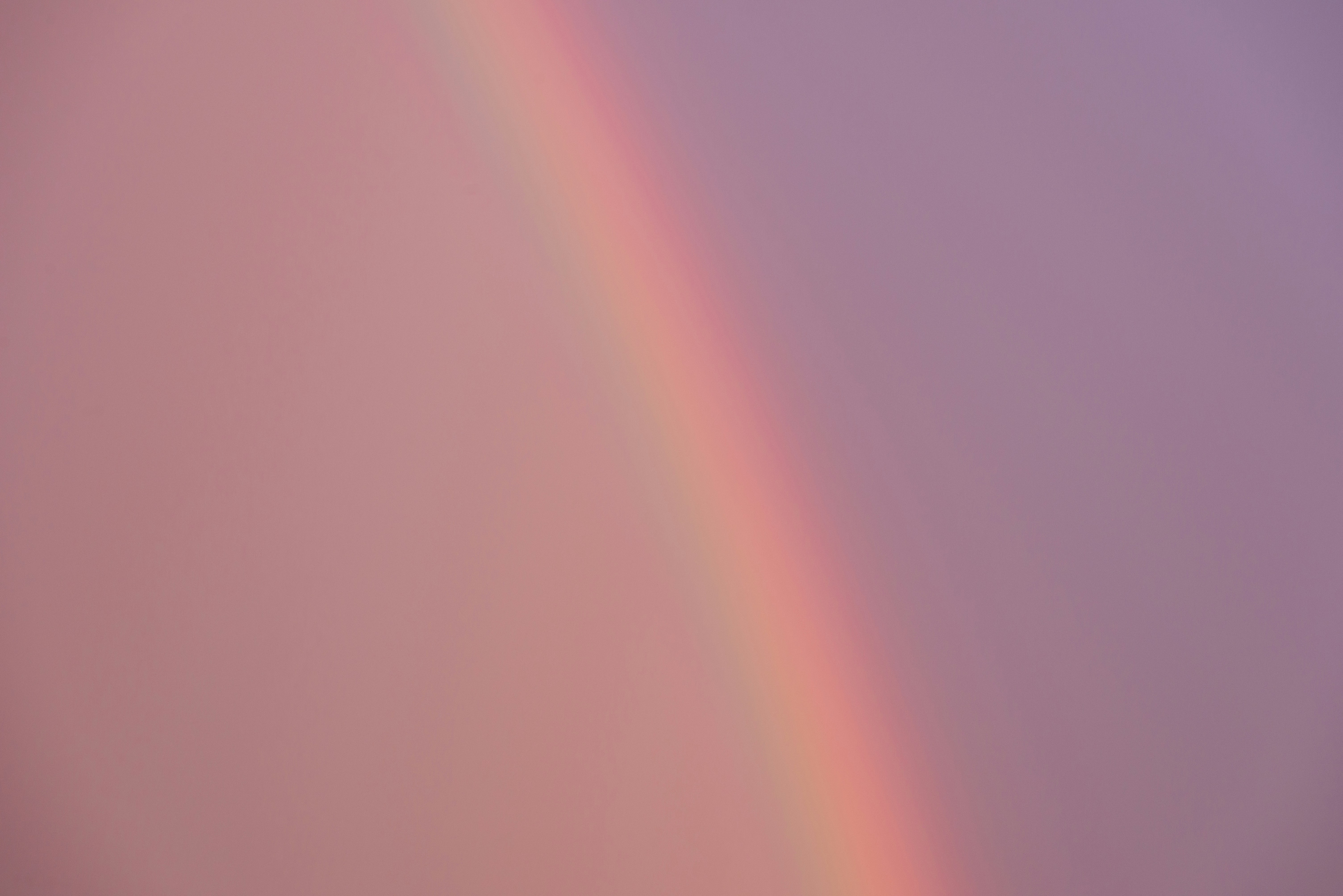 Arc of Light: A Soft Rainbow Across a Pastel Sky