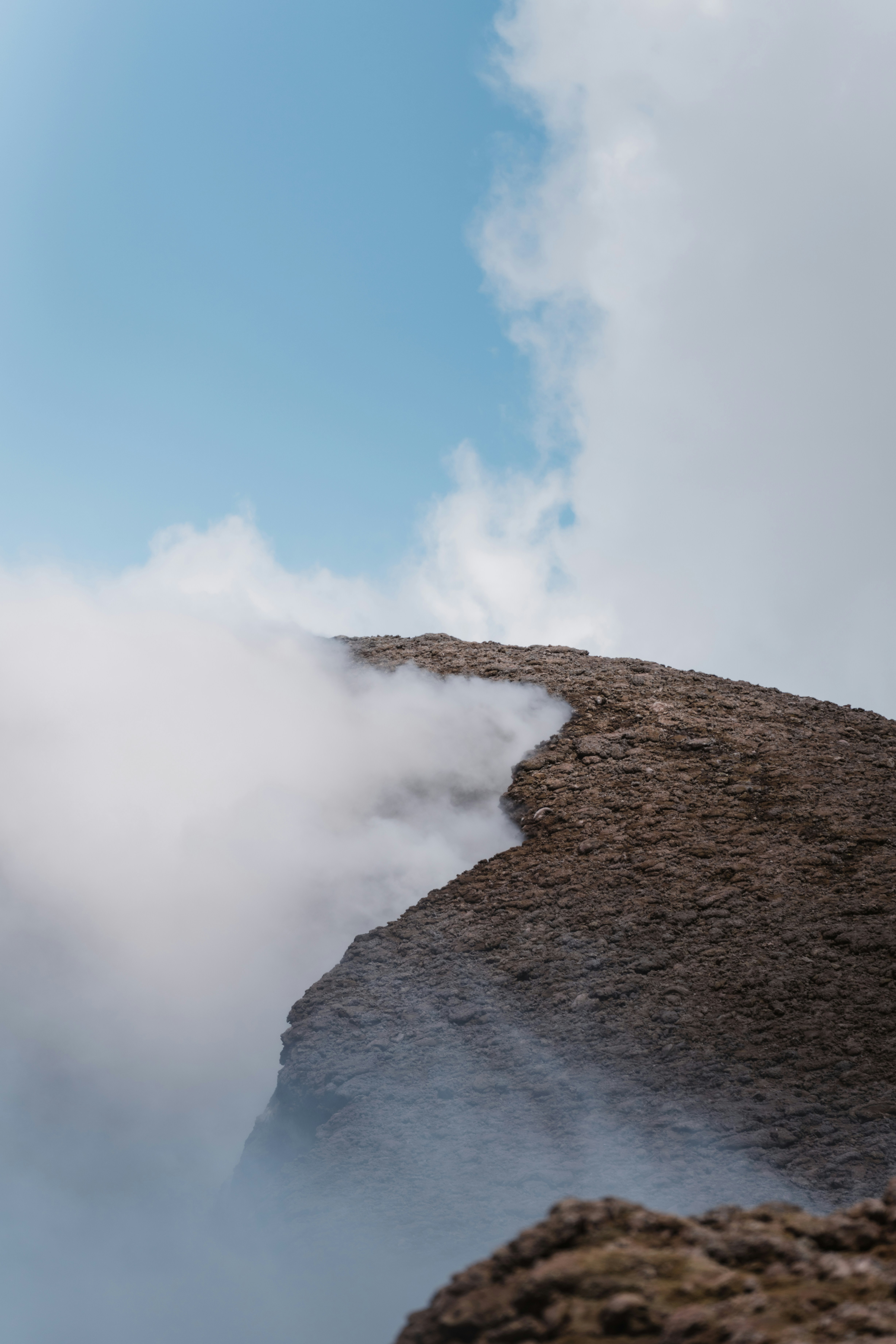 Clouds Wrap the volcanic ridge: a quiet ascent above the mist