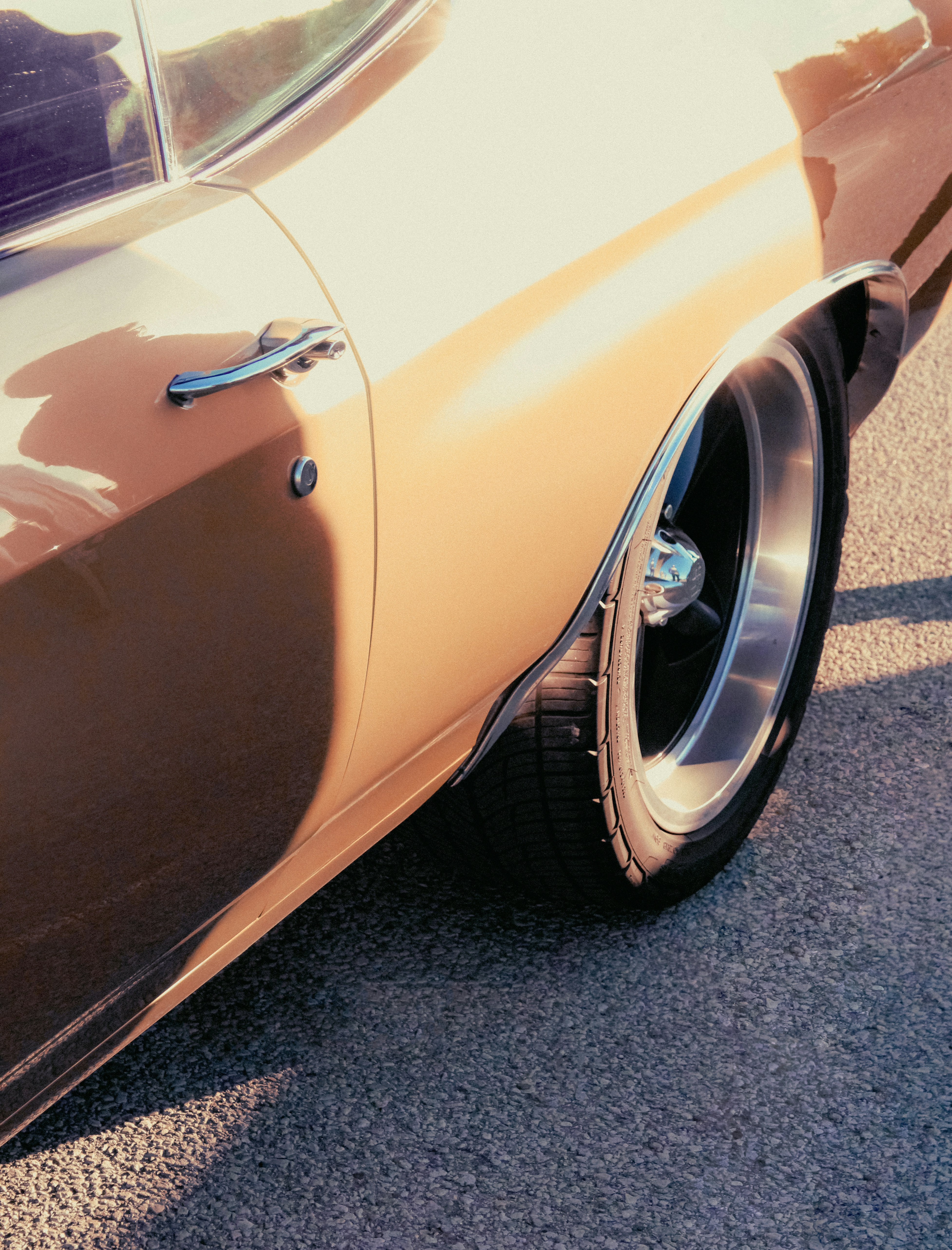 back wheel of classic vintage car in setting sunlight