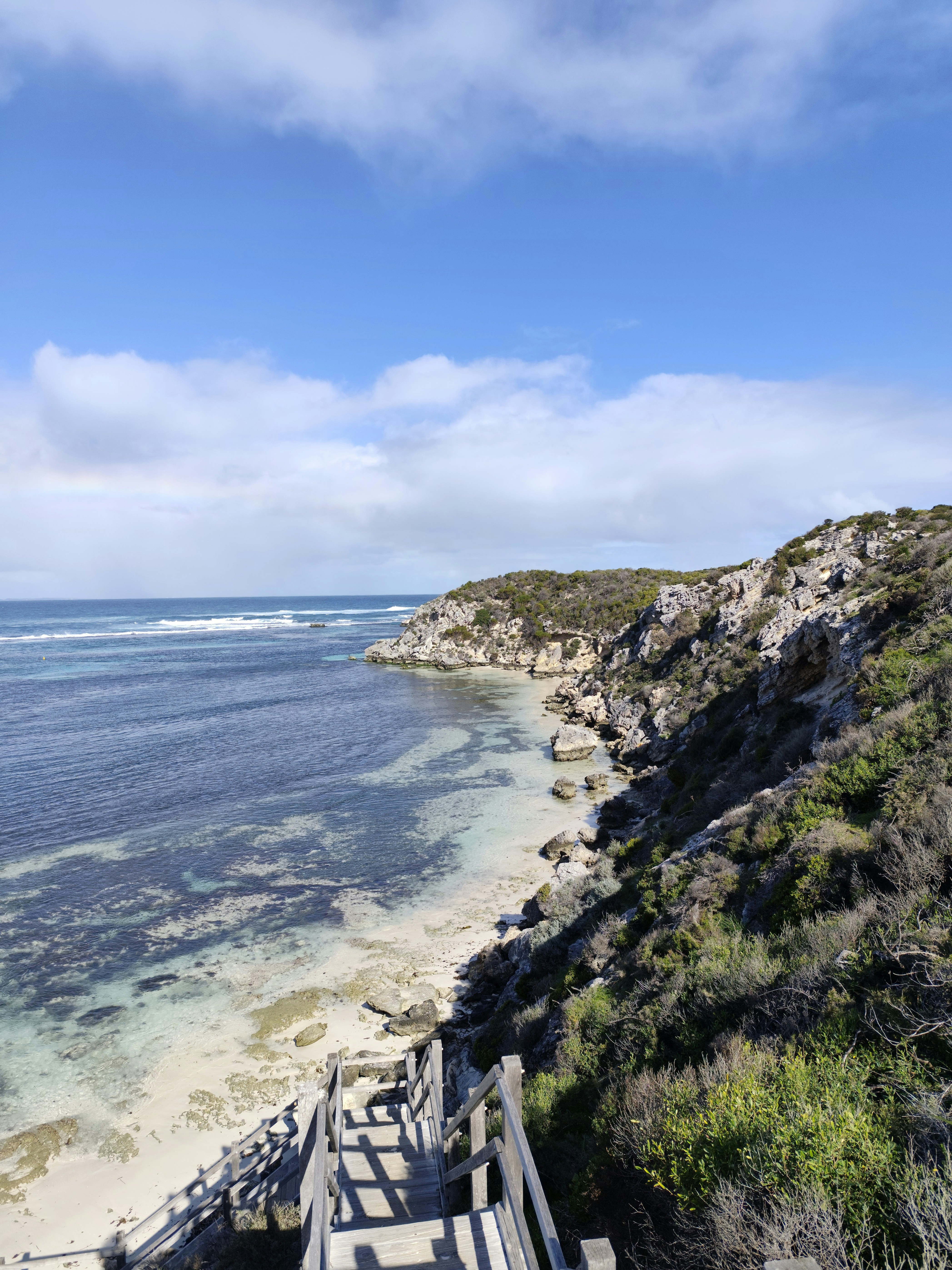 Ridge Steps to the Sea: A Cliffside Path Toward Clear Blue.