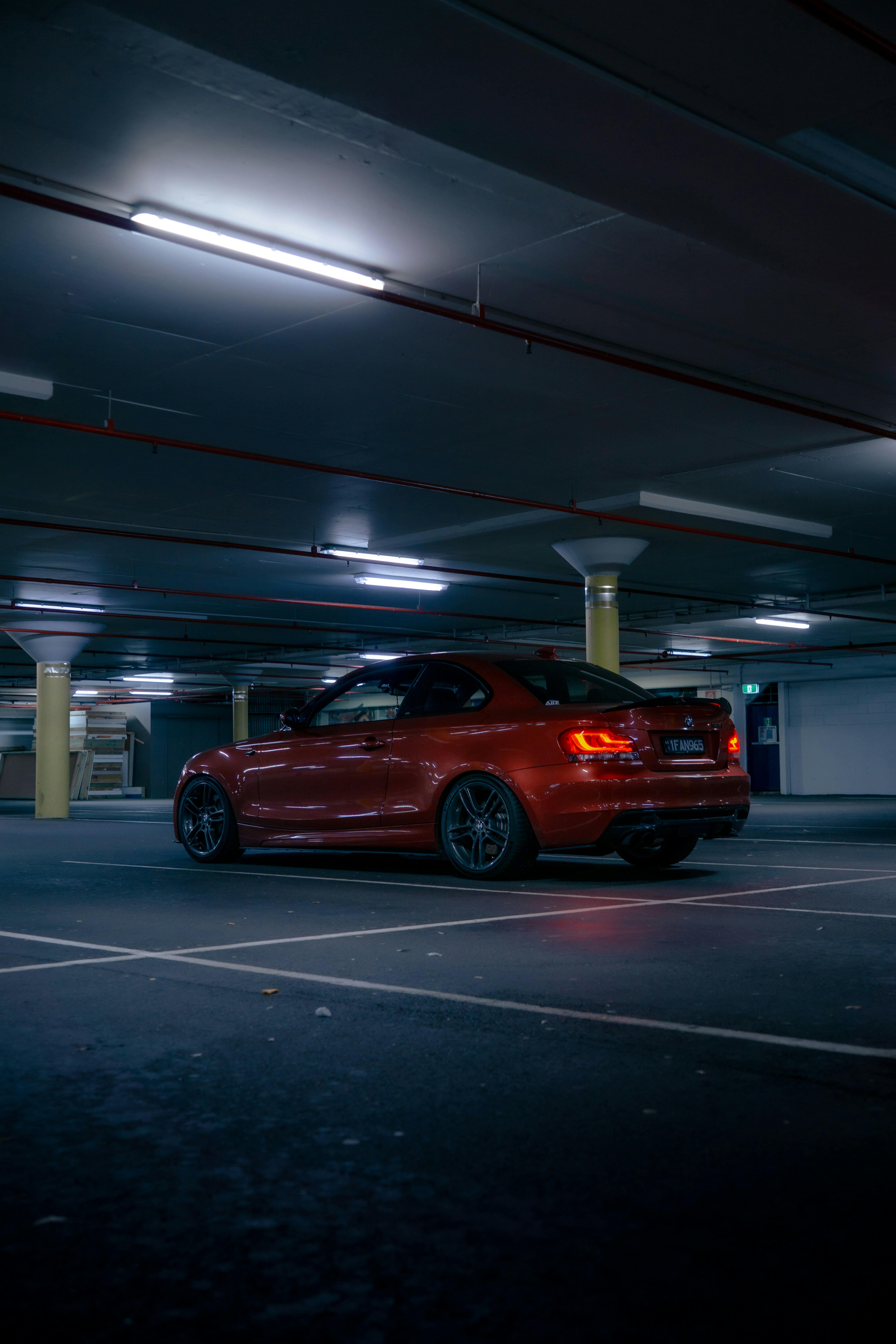 Red Sports Car in an Underlit Parking Garage