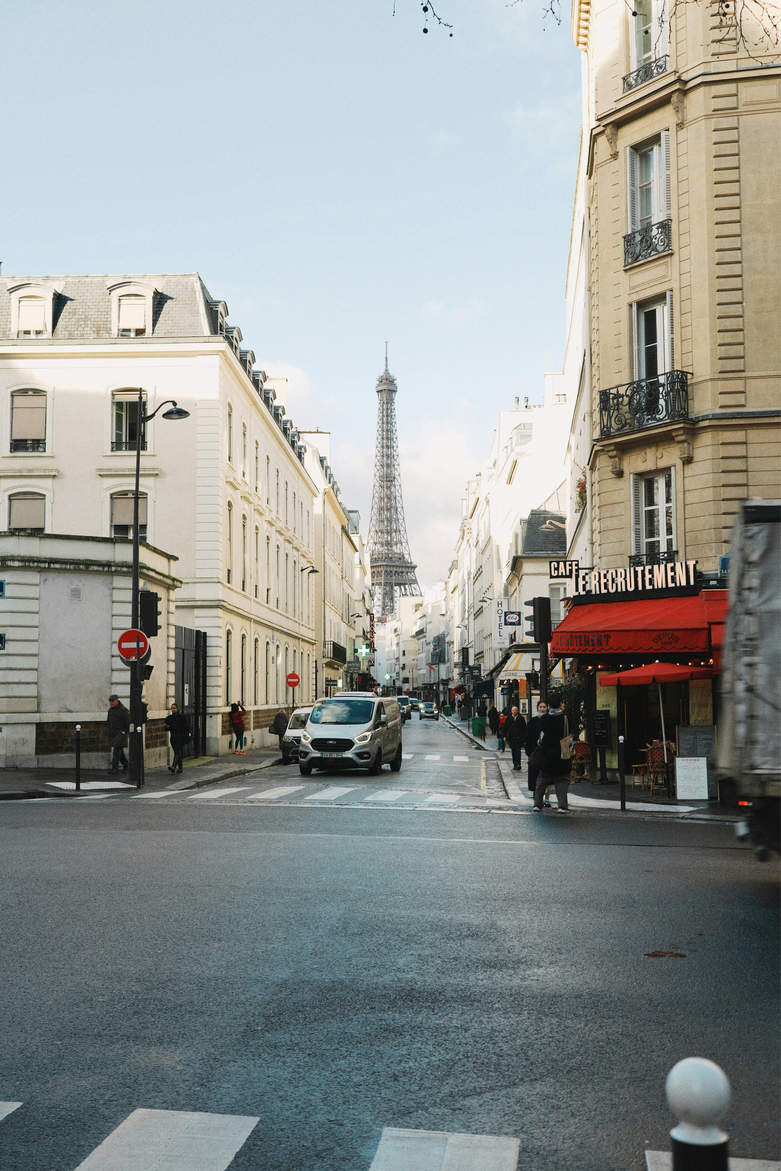 Parisian Street Ascent: The Eiffel Tower Framed by Haussmannian Facades