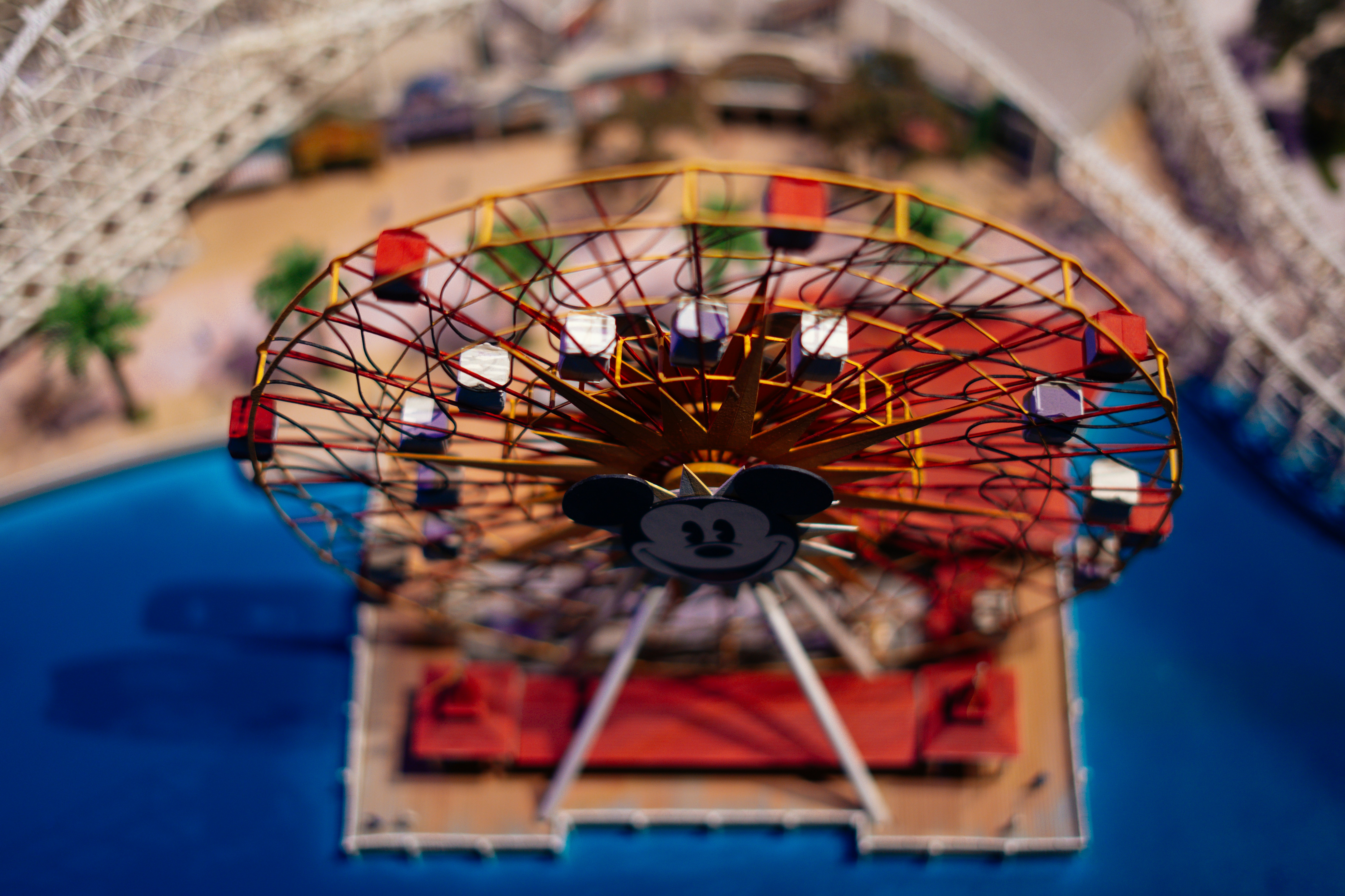 Aerial Tilt: A Top-Down View of the Parked Ferris Wheel over a Pool