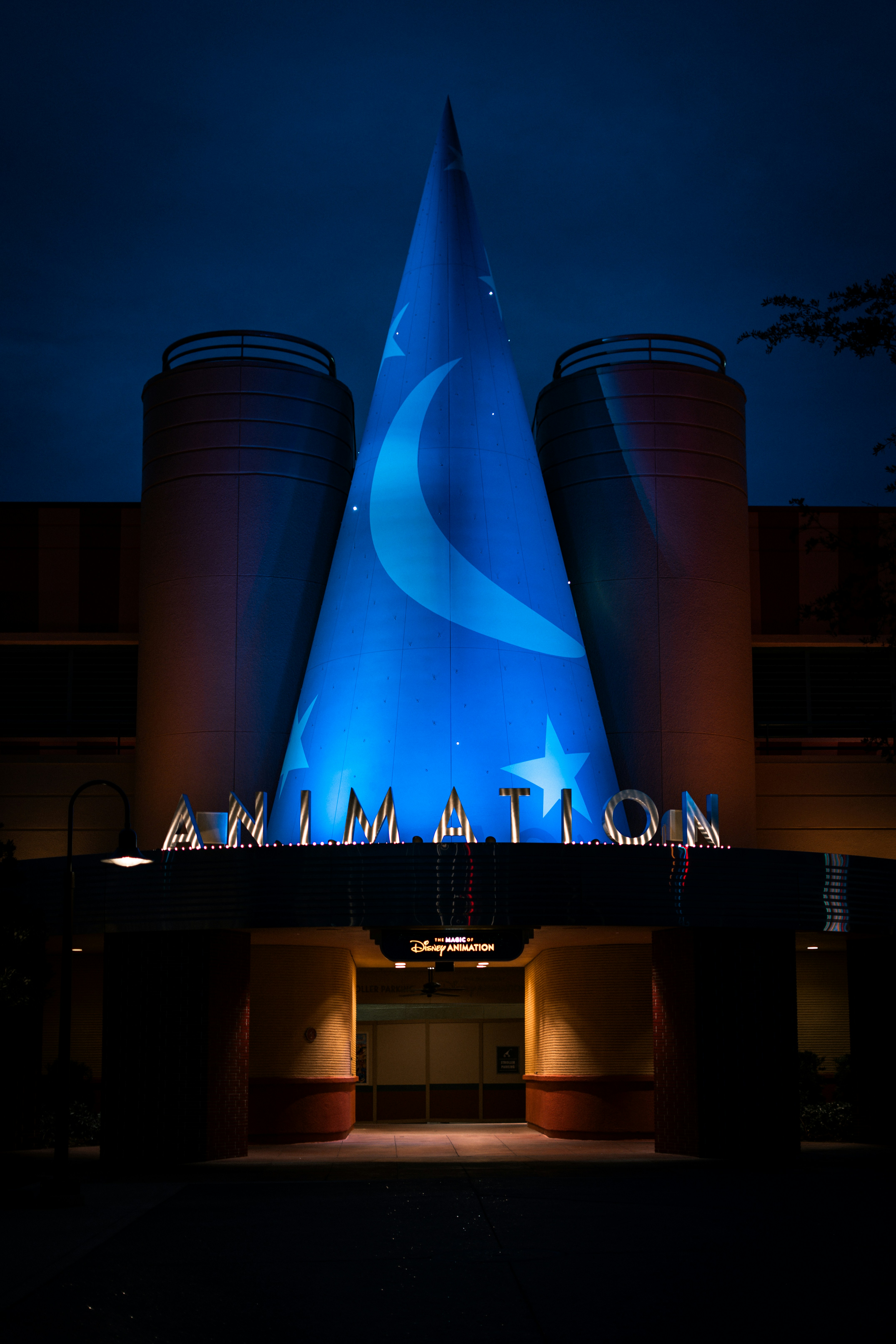 Blue Cone of Animation: Night Entrance Under Moonlit Signage