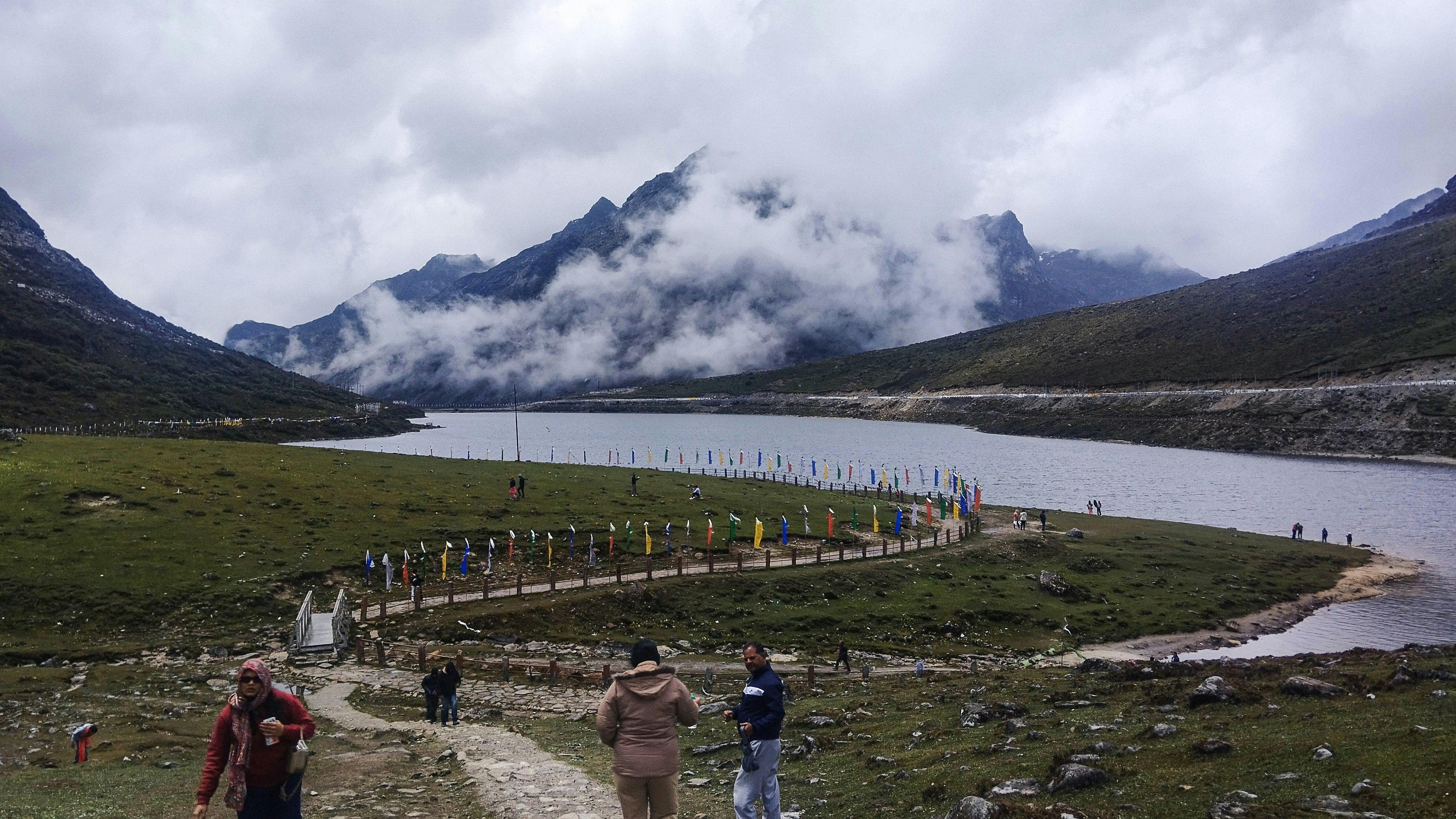 Prayer Path by the Fjord: Monolithic Peaks and a Ribbon of Pilgrims