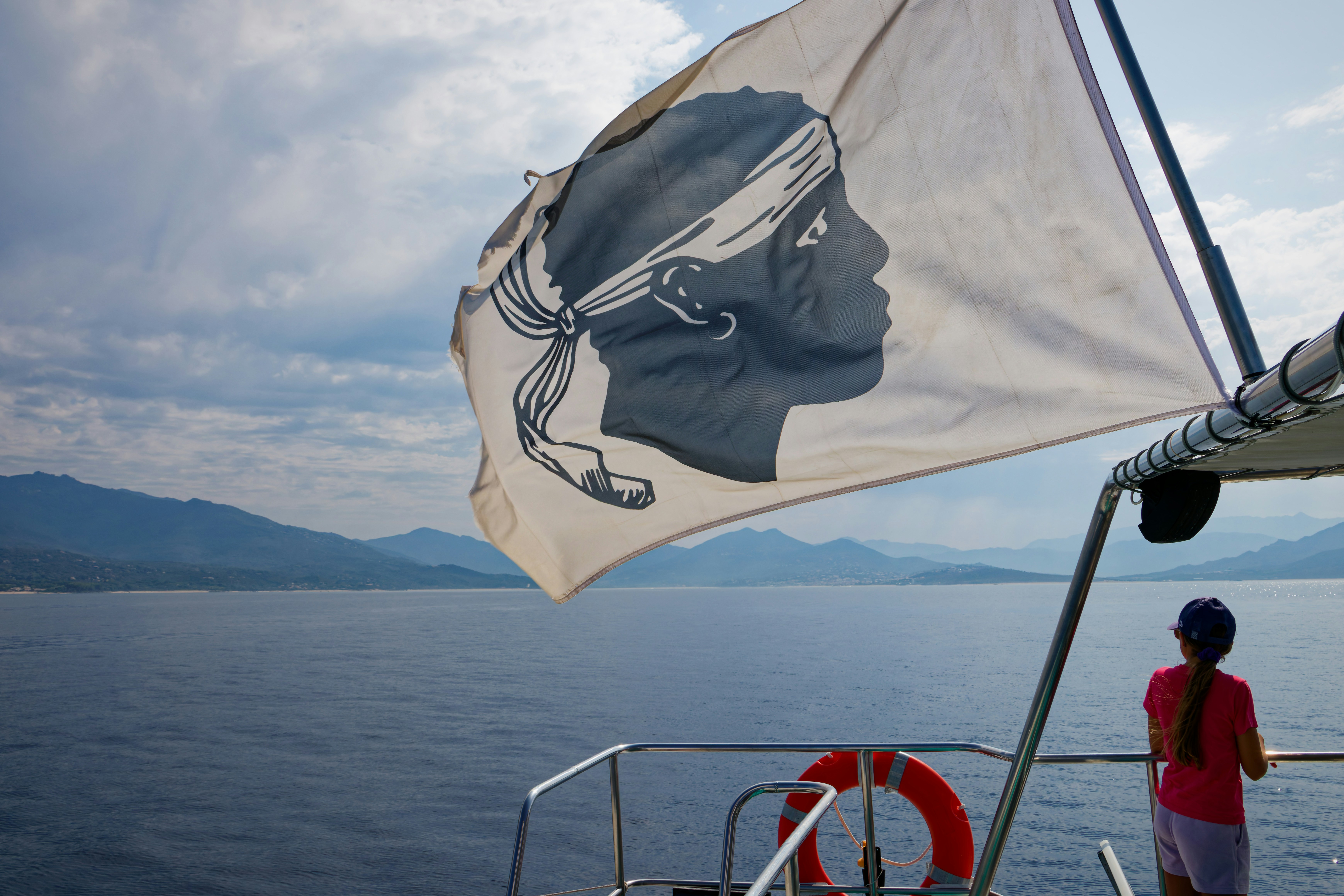 Flag in the Breeze Over a Seafaring Calm