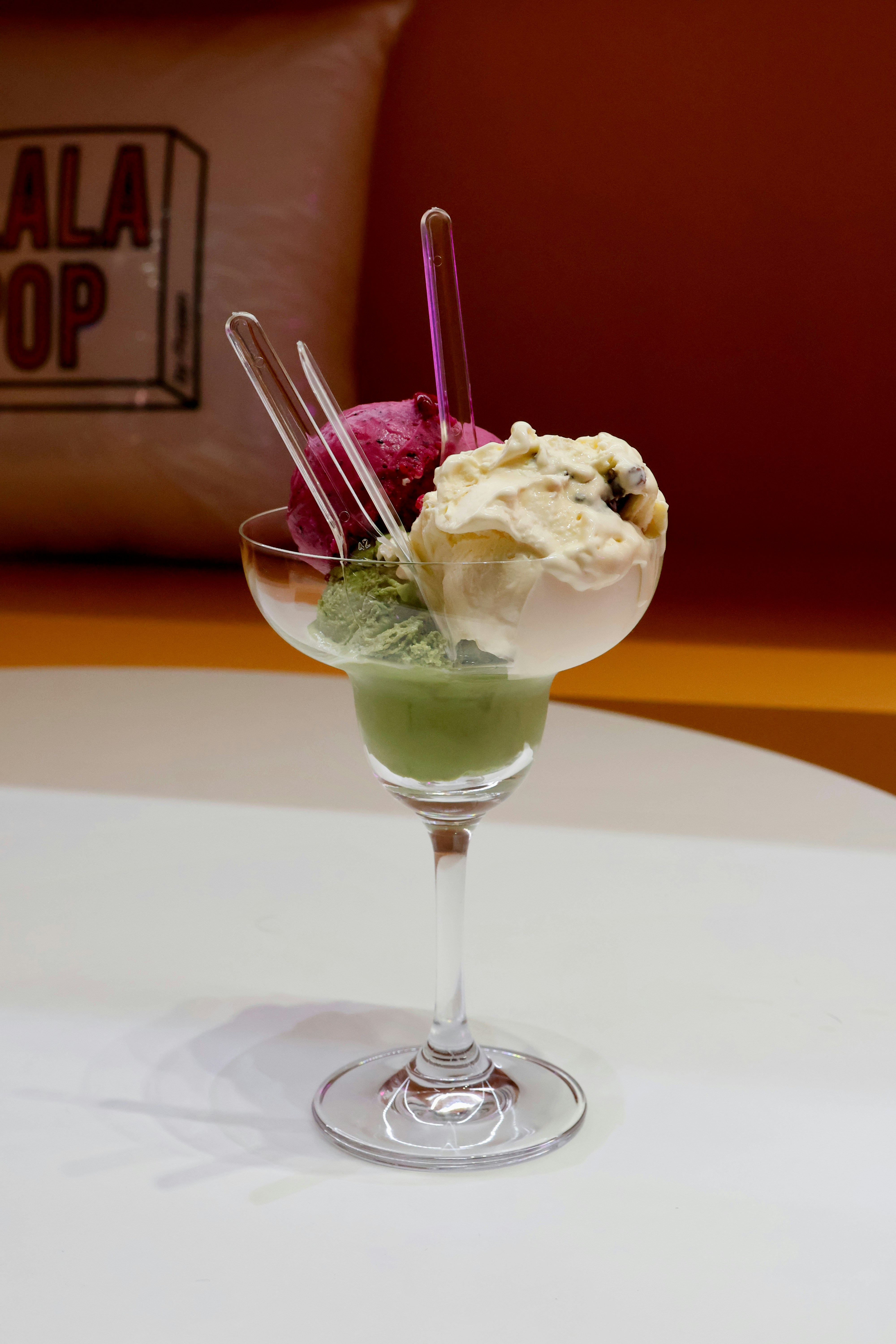 Triple Scoop Serenade: A Glassful of Ice Cream on a Minimal Stage